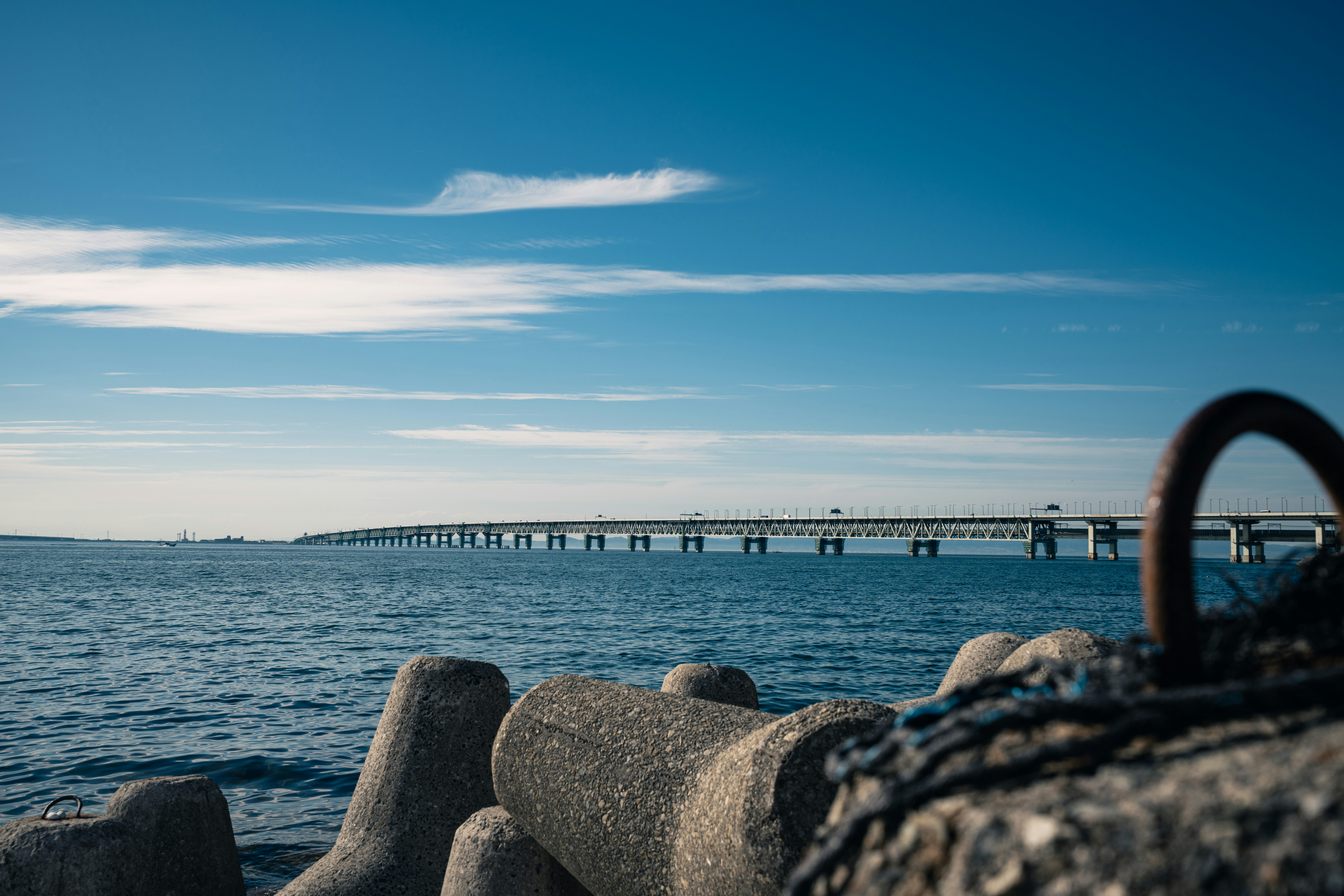 Edge of Quiet Blue: A Pier Stretching Toward the Horizon