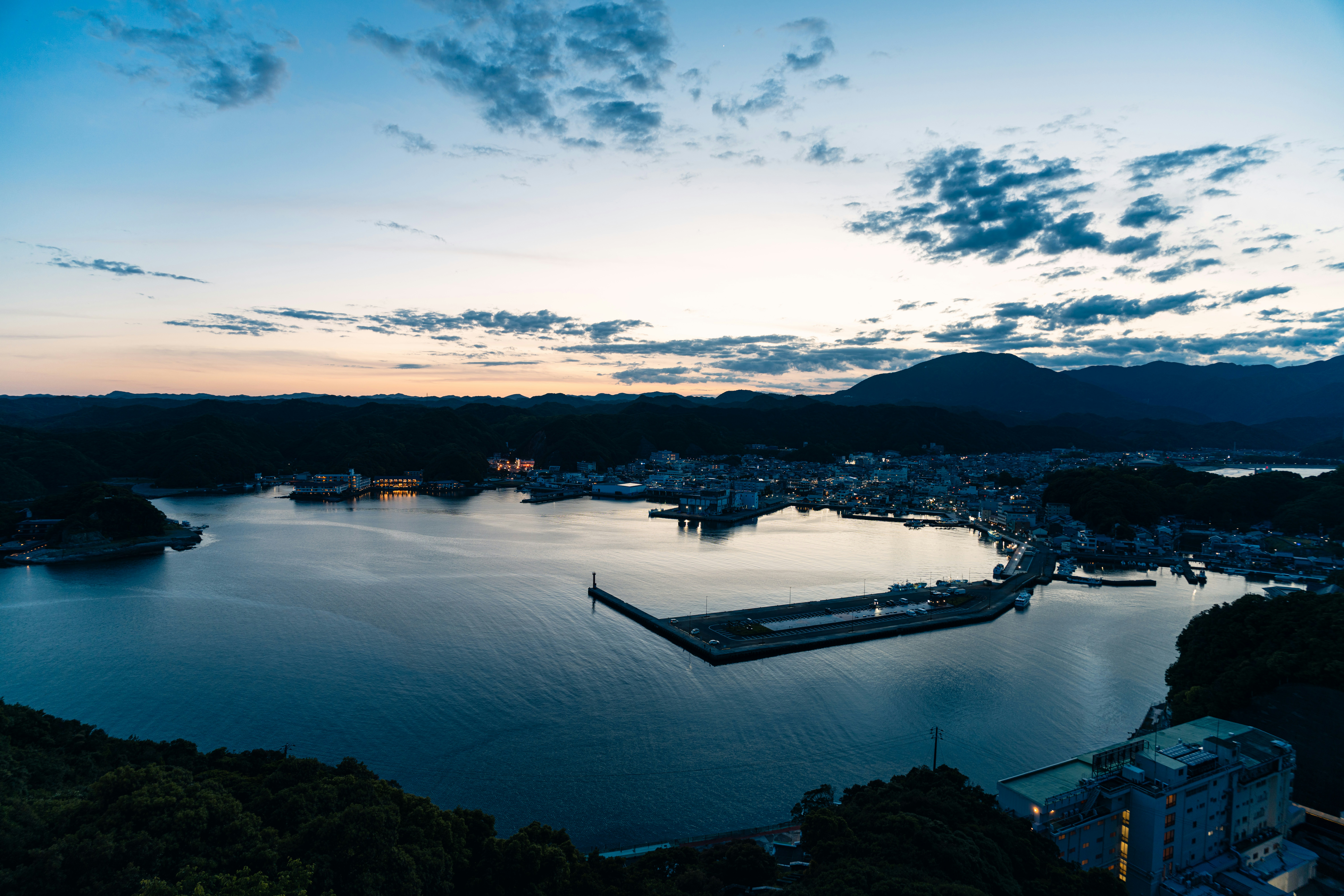 Dusk Harbor: Calm Basins and Silhouetted Breakwater