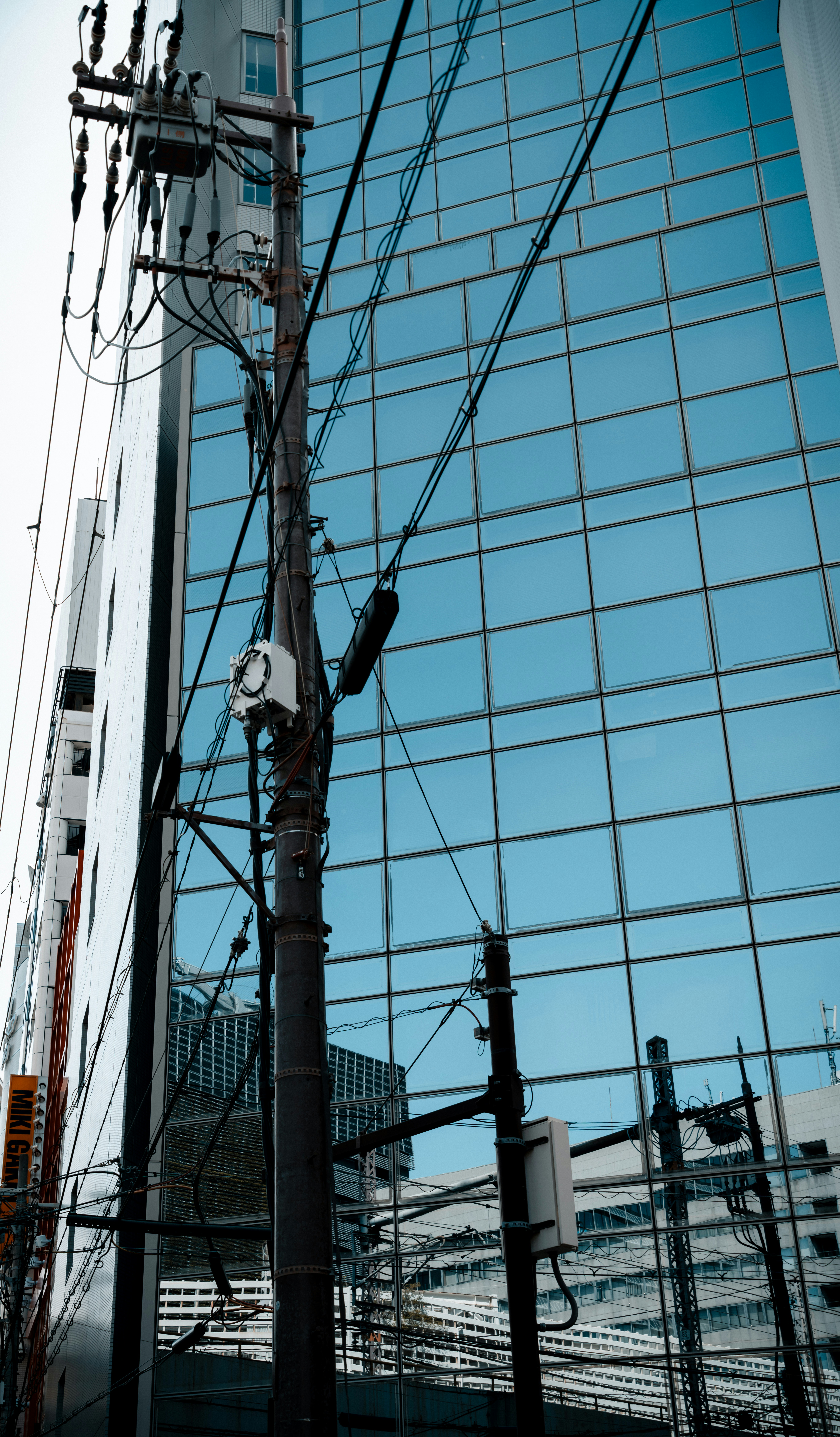 Urban Grid: Power Lines Framing a Glass Corner