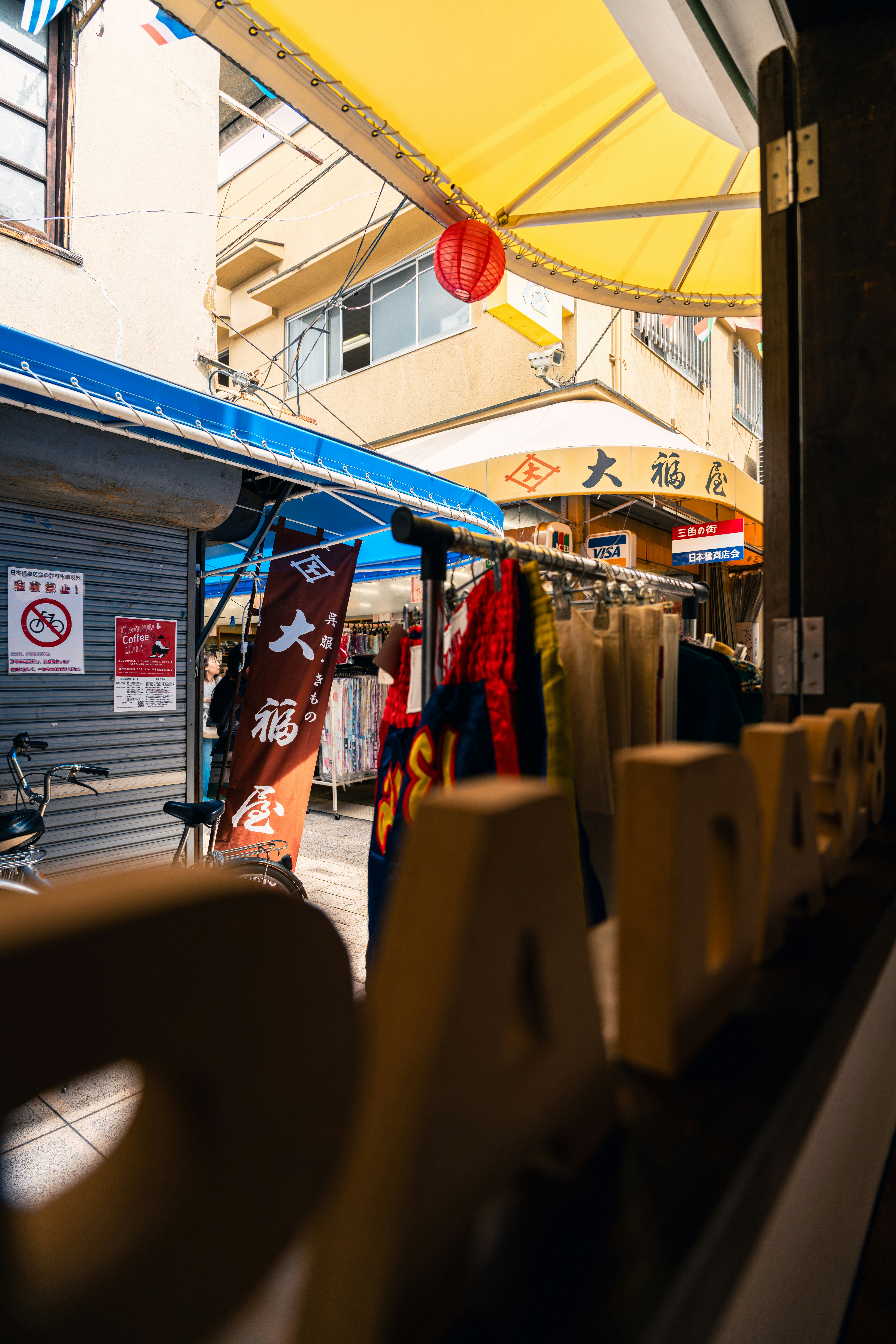 Market Stall Corridor Under a Bright Yellow Canopy