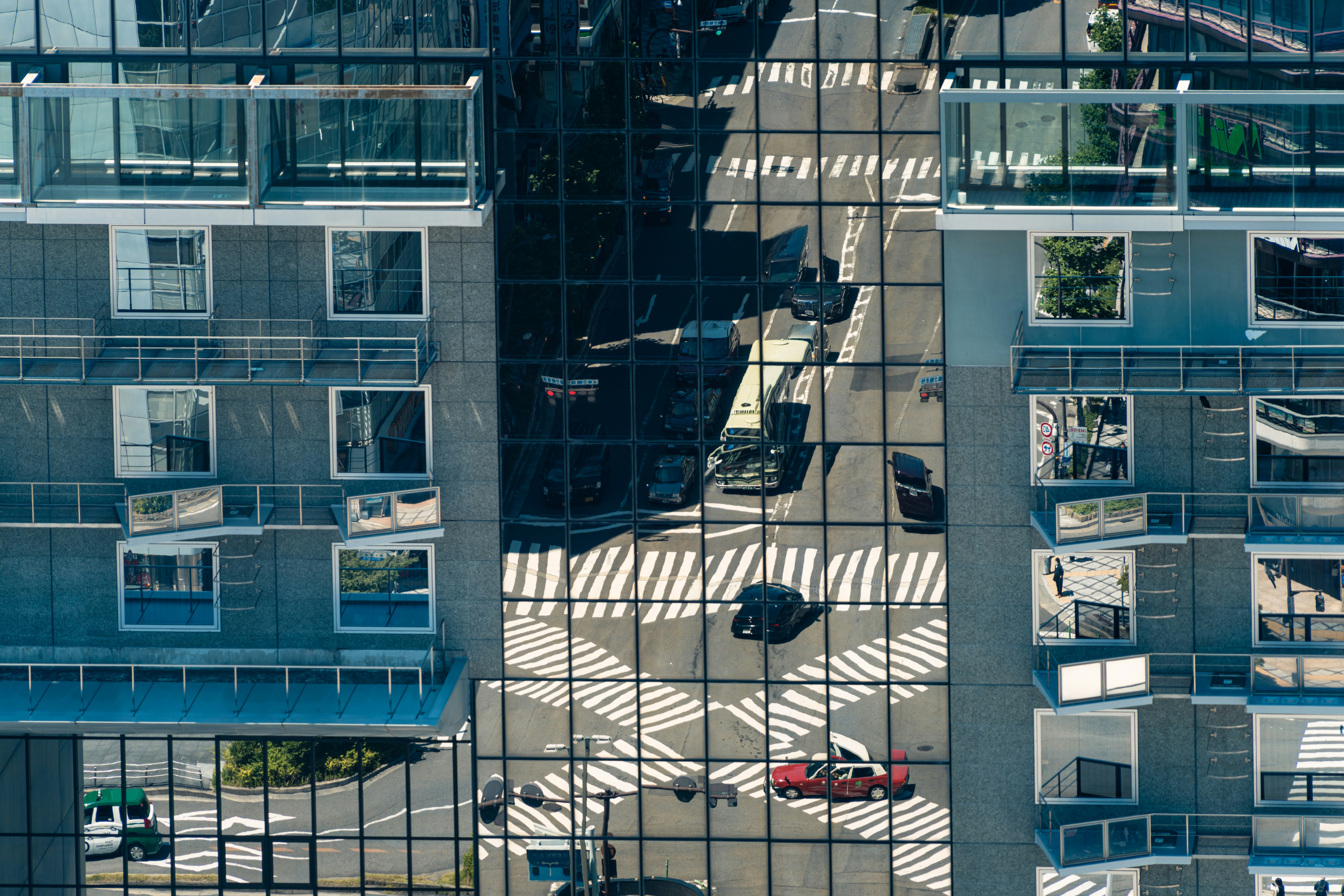 Aerial Glassed Avenue: Reflections and Traffic in a Skyscraper Mosaic