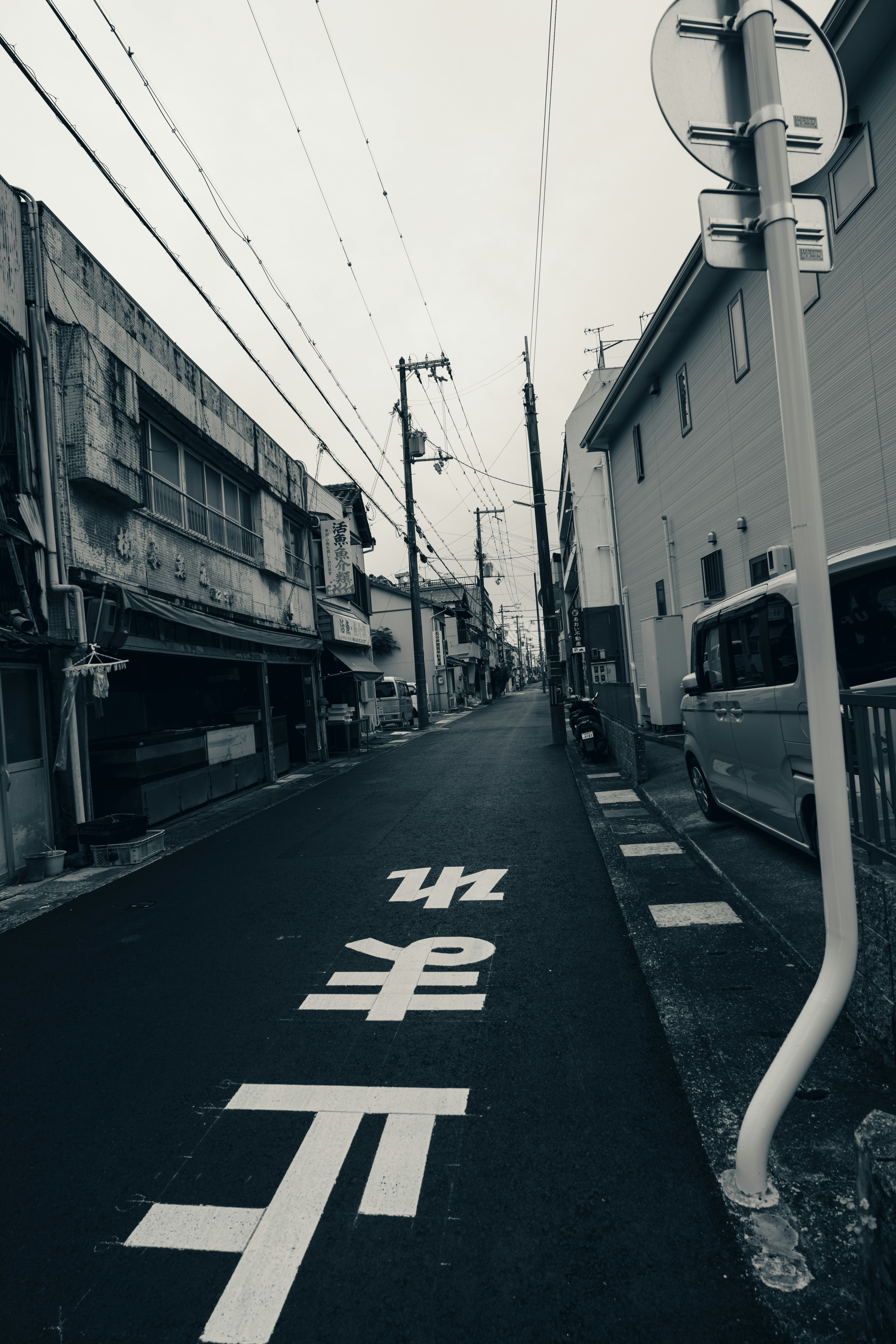 Urban Monochrome: Narrow Street vanishing into the distance