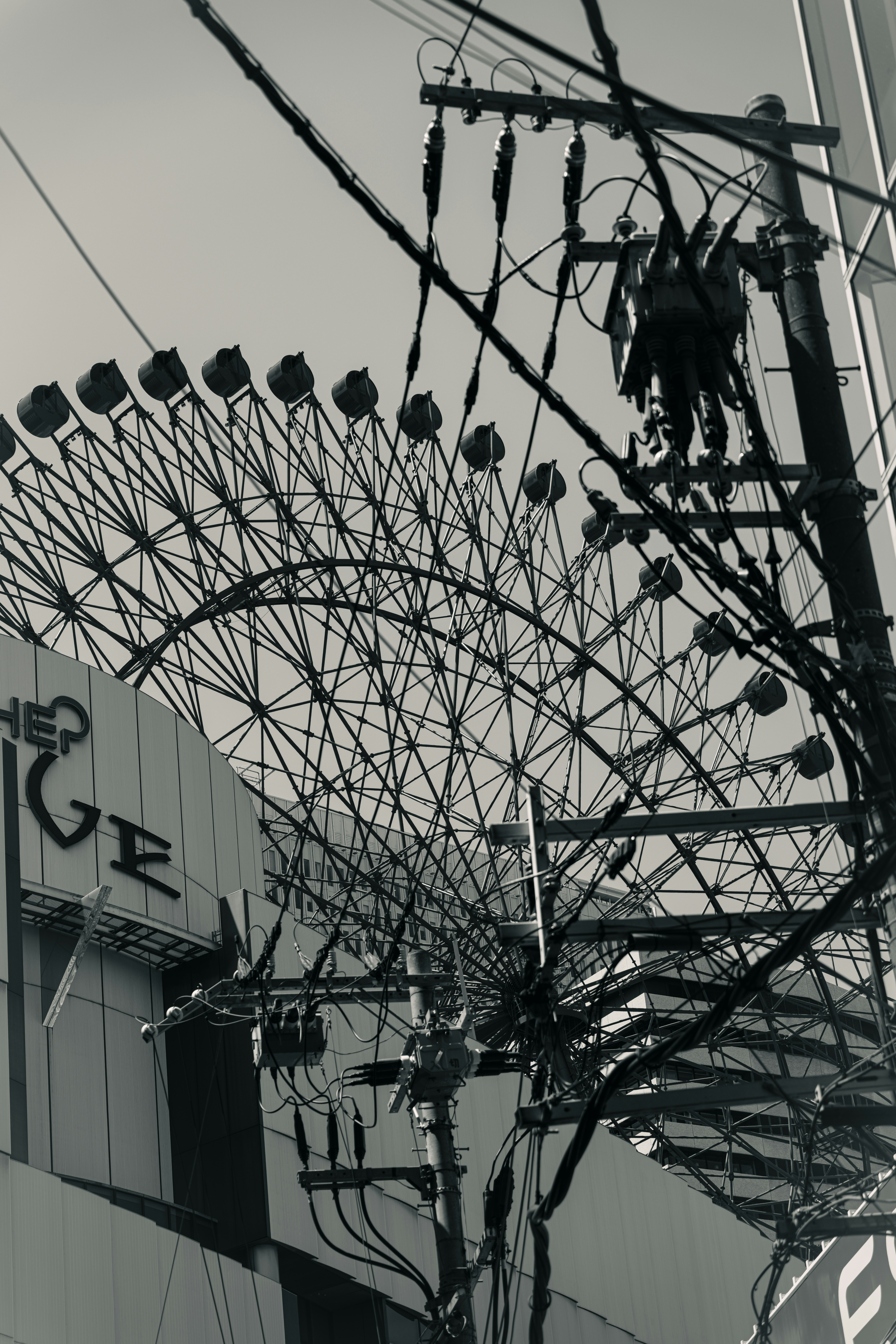 Urban Ferris Wheel Frame: Electrical Lines and Signage in Monochrome
