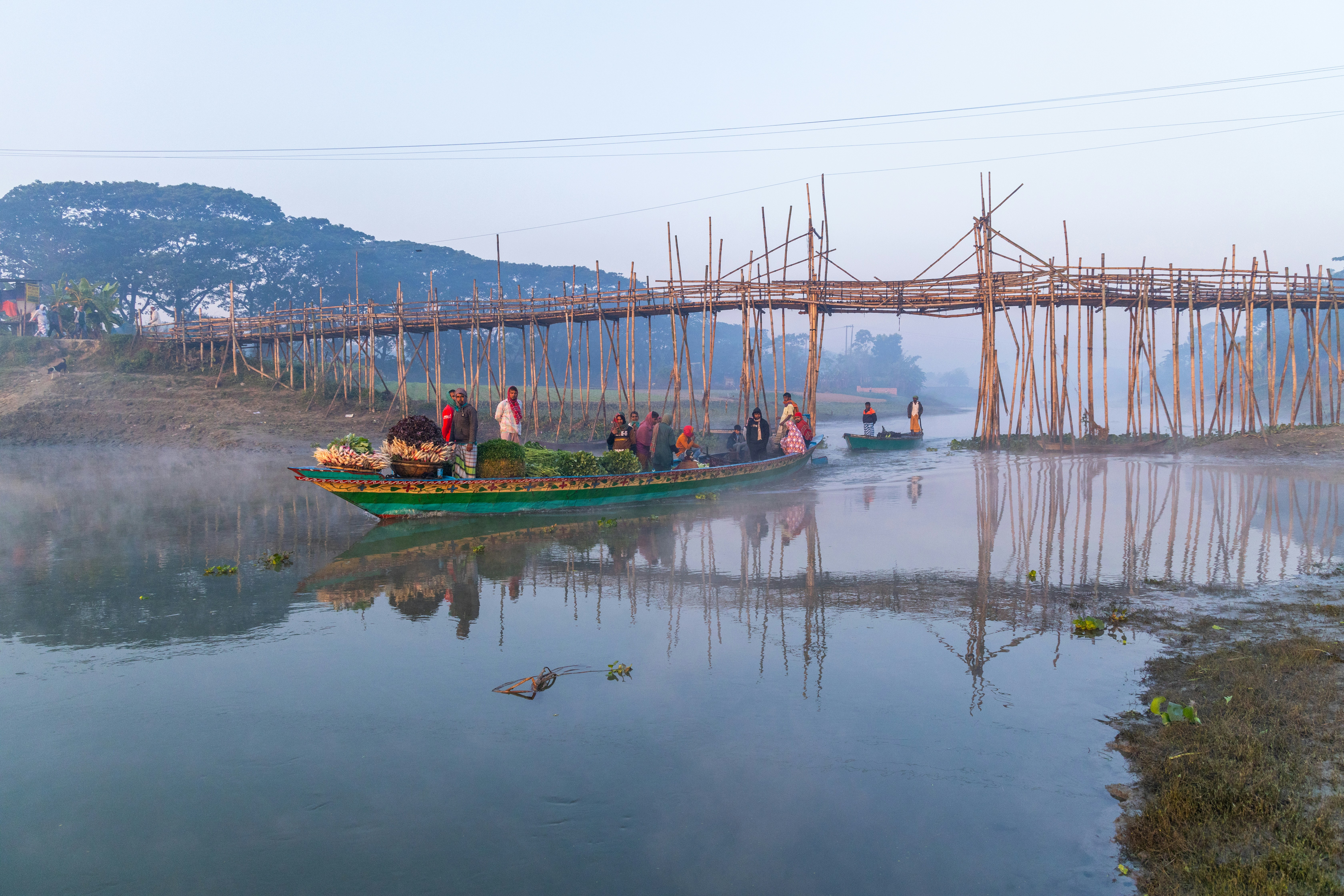 Floating Market on Misty River Crossing a Wooden Span