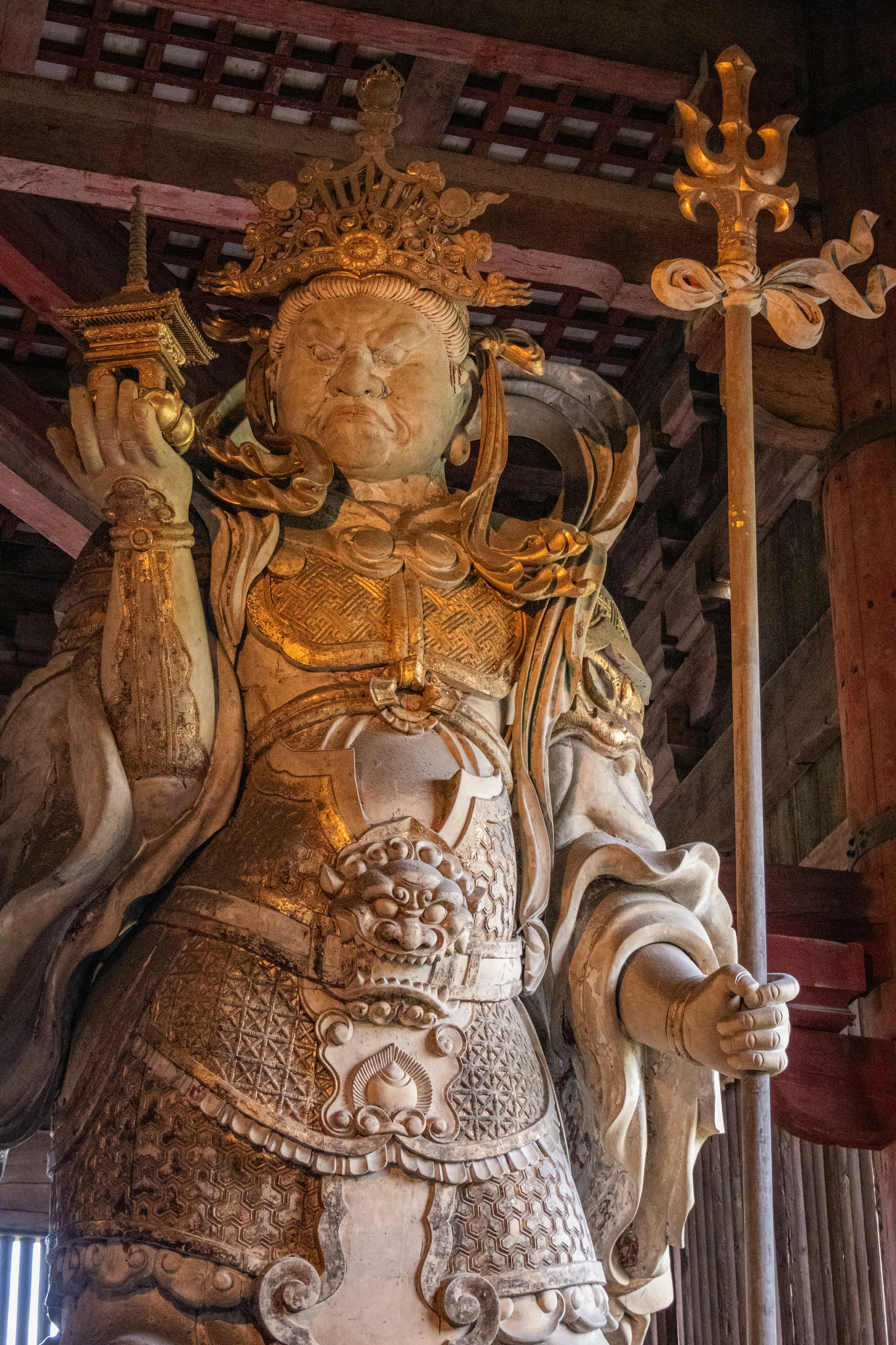 A large carved wood statue of Tamonten (Vaiśravaṇa), also known as Bishamonten, one of the Four Heavenly Kings (Shitennō) in Buddhist tradition.