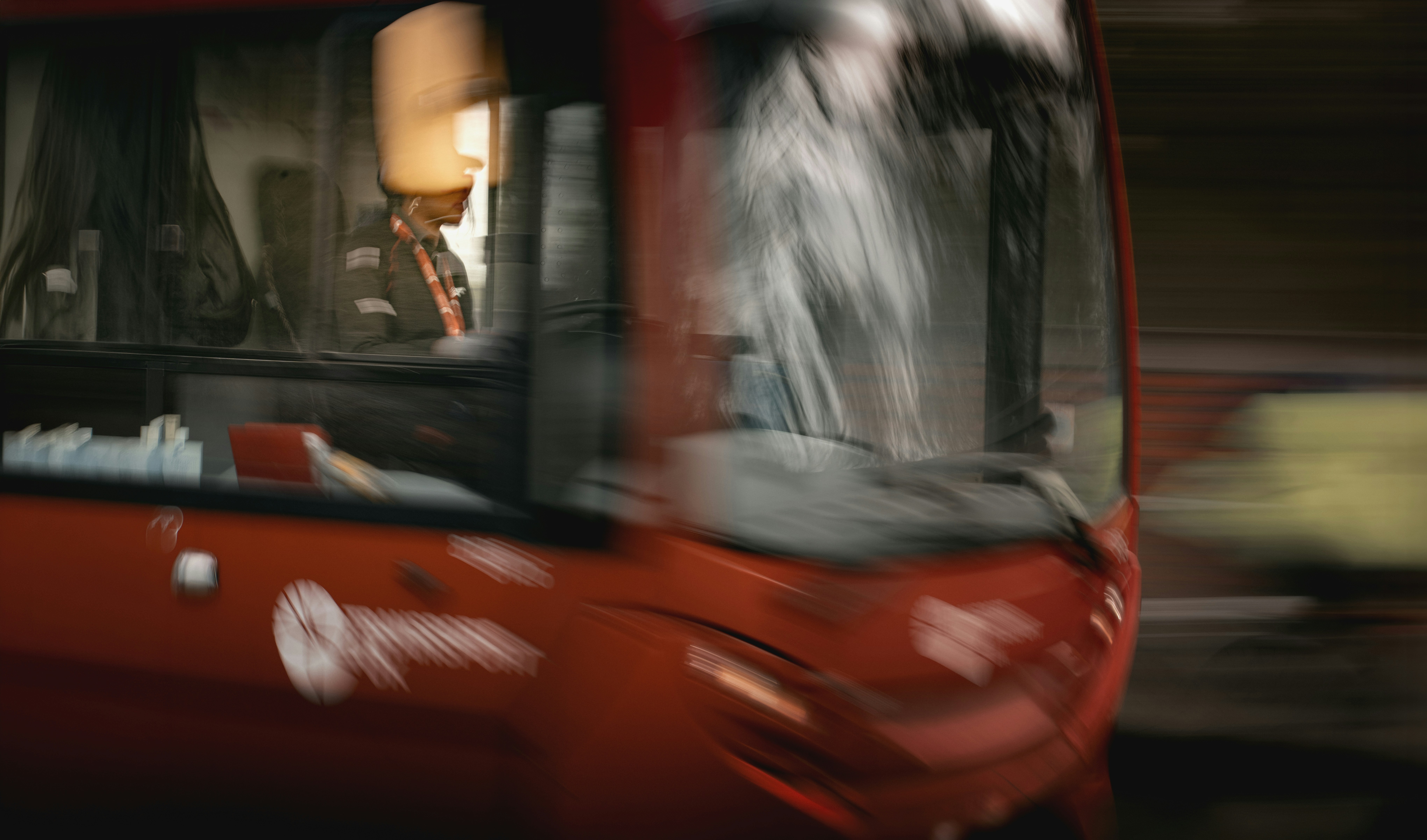 Blurred Red Bus in Motion: A Burst of Urban Transit