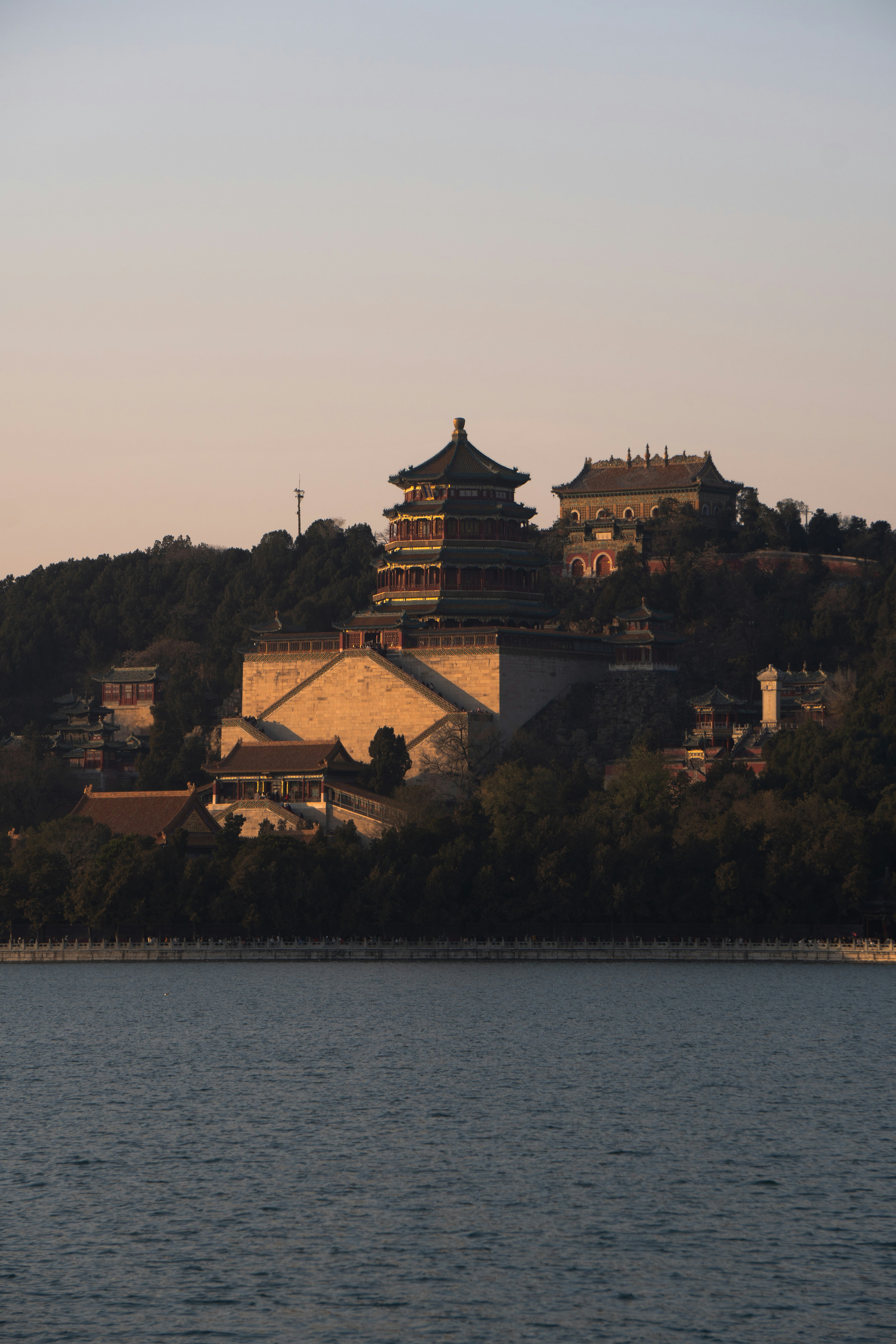 Ancient Pavilion Rising Above the Lakeside Hills at Dusk