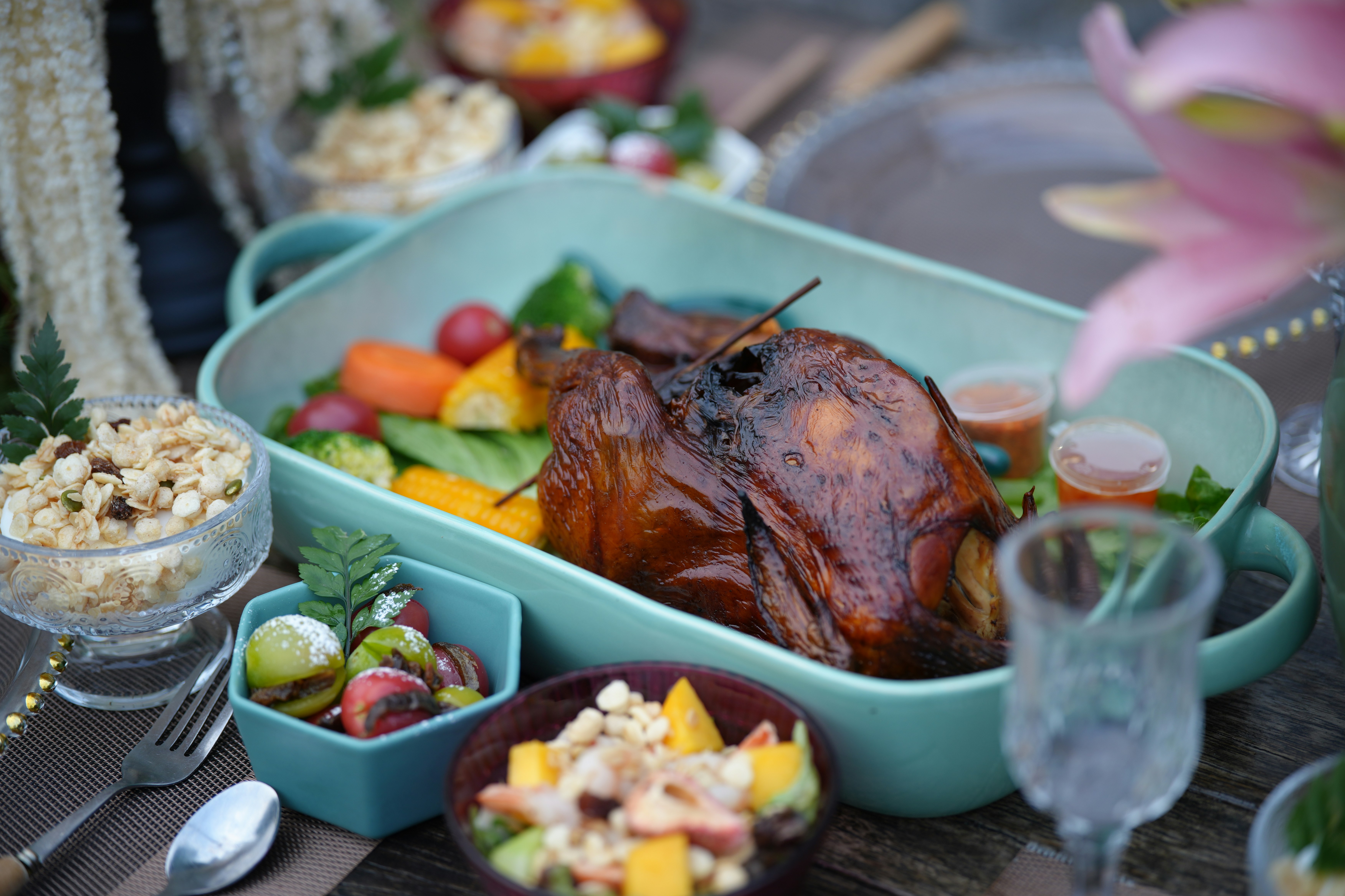 Roasted turkey and vegetables served on a festive table.