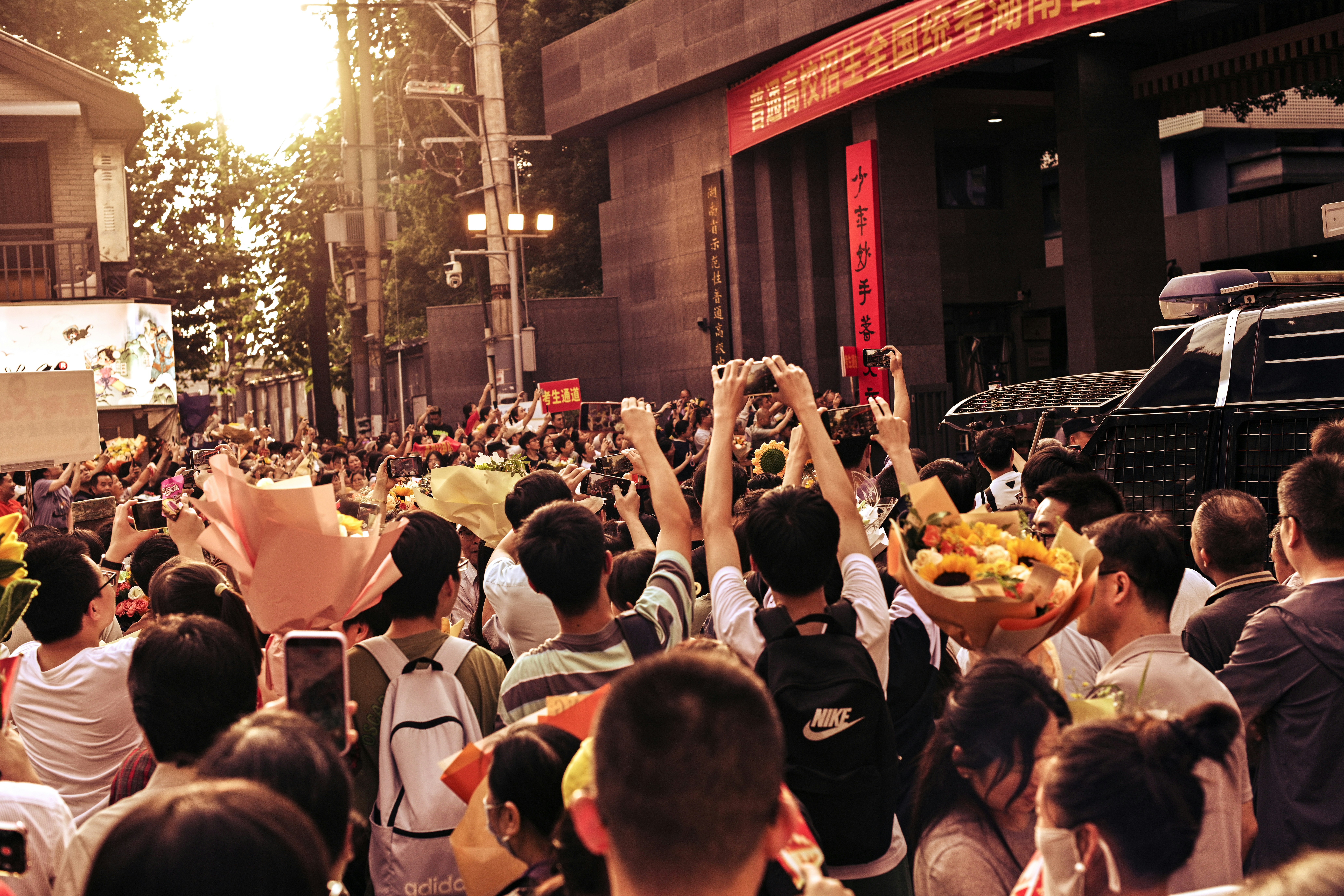 Crowd at the Street Exit: A Sunset-Partied Moment Amid Urban Festivities