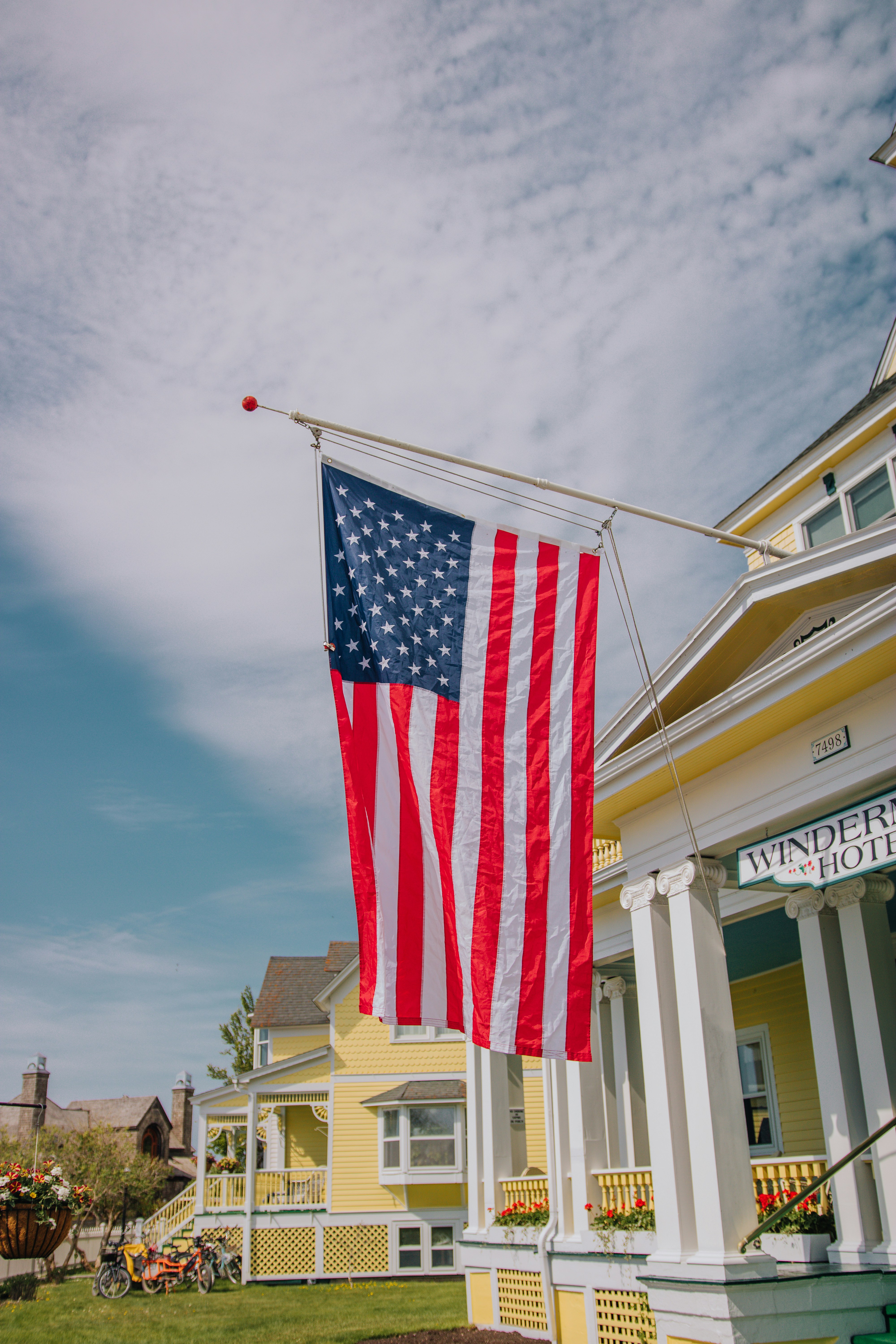 Flag Over a Coastal Inn: A Slender Banner Dwelling in Bright Daylight
