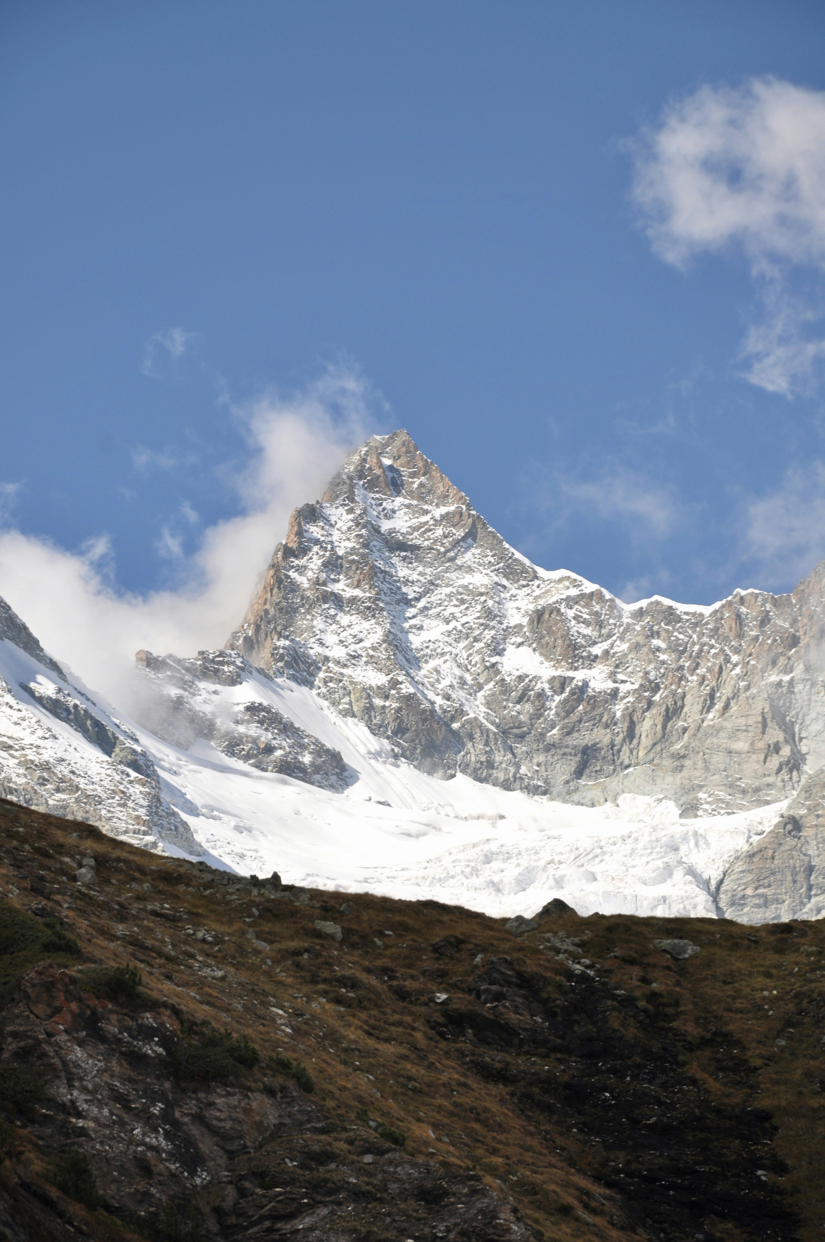 Snow-Glazed Summit Carving Through A Clear Alpine Sky