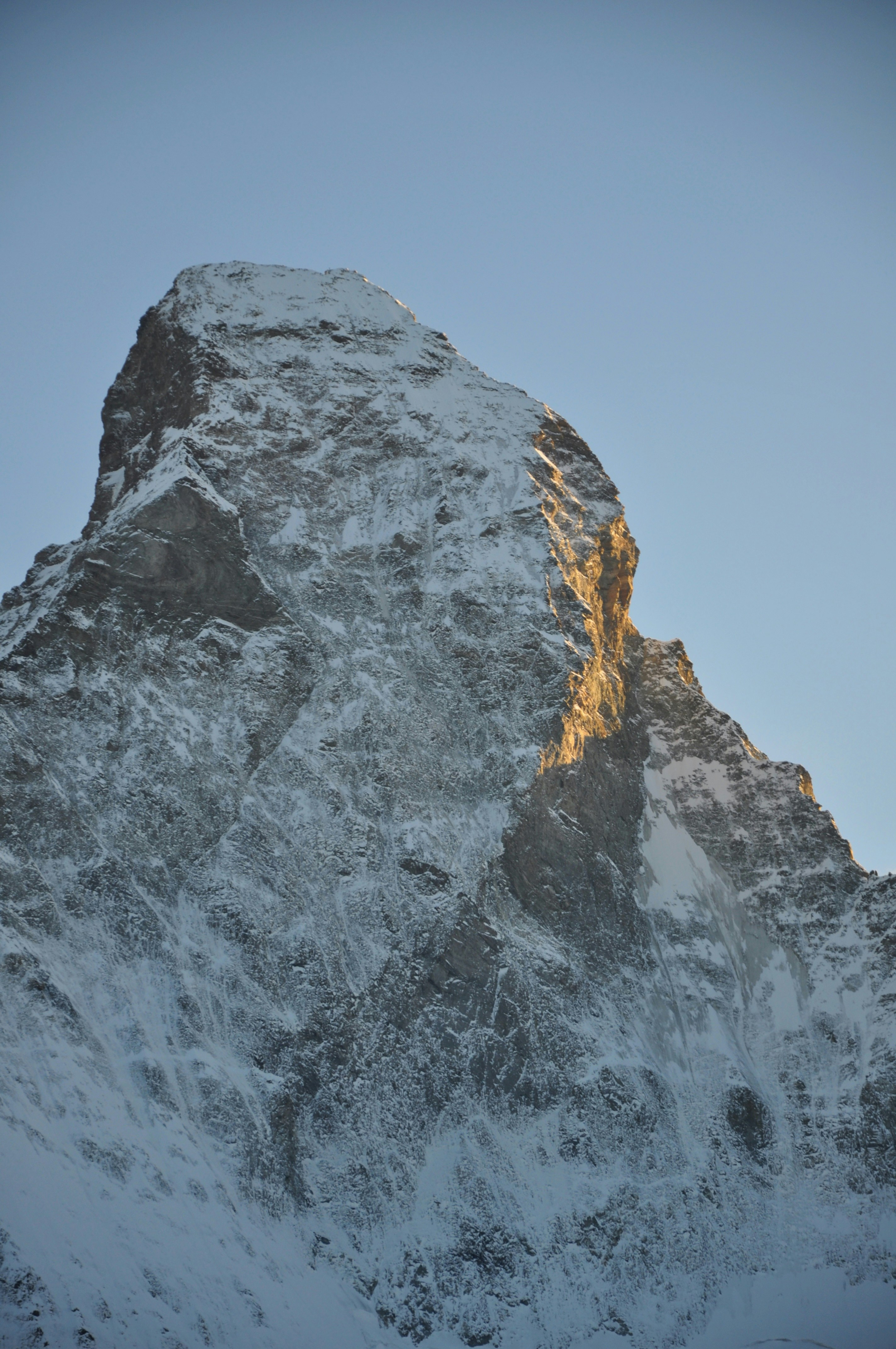 Sunlit Summit: The Peak Bares Its Golden Face
