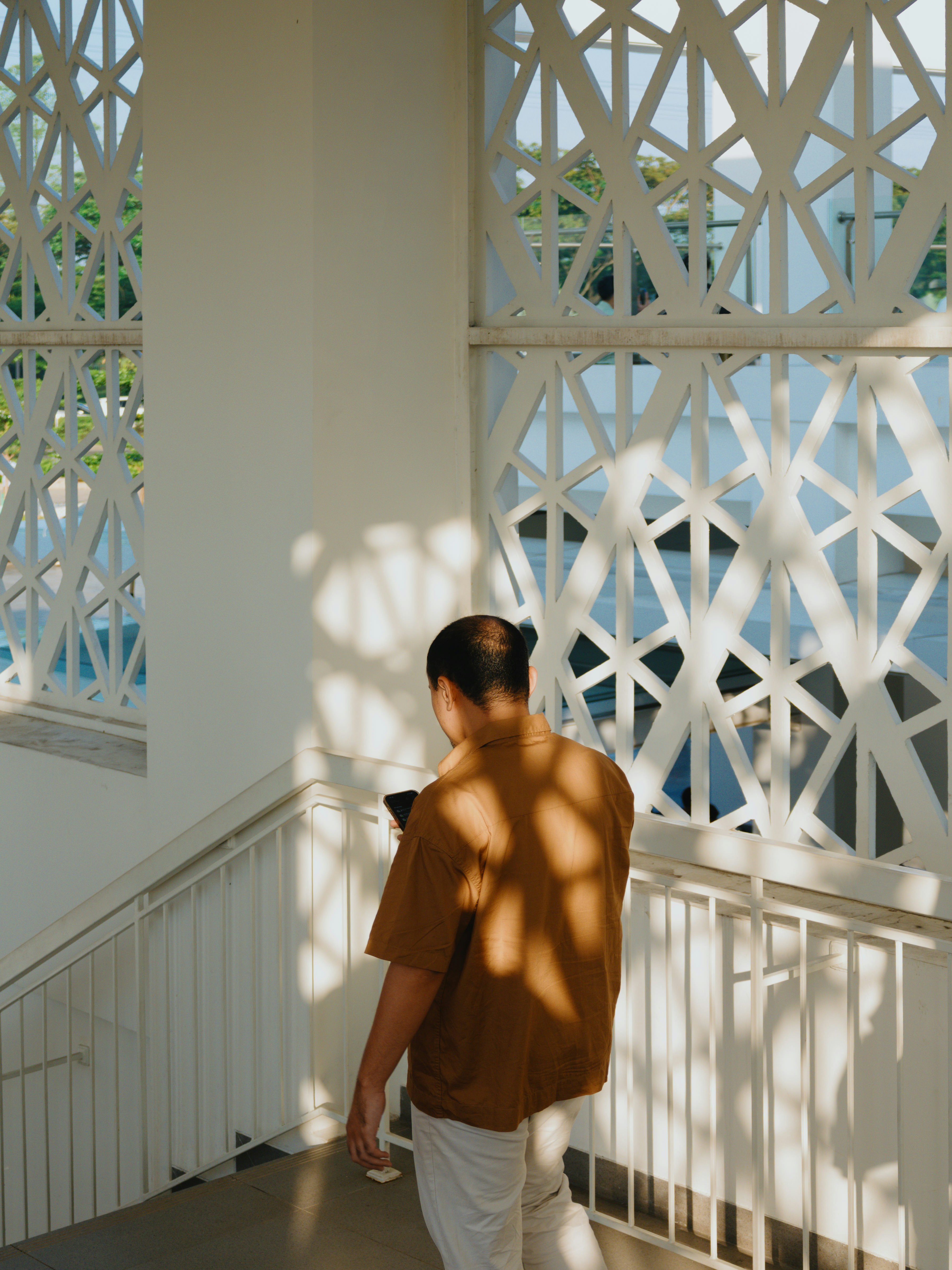 Shadow Patterns and Quiet Focus: A Stairwell Moment