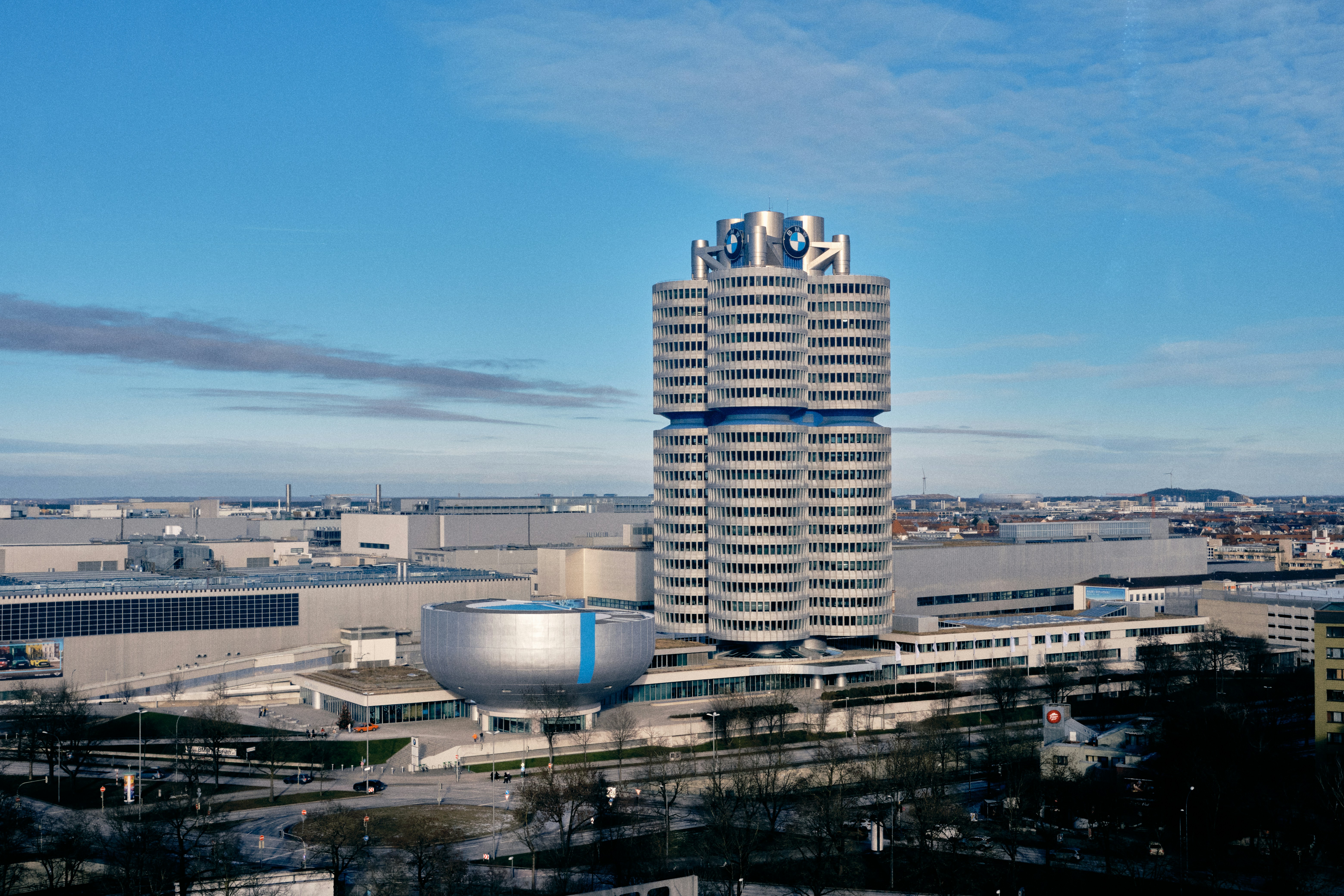 BMW headquarters and museum building under a clear blue sky.