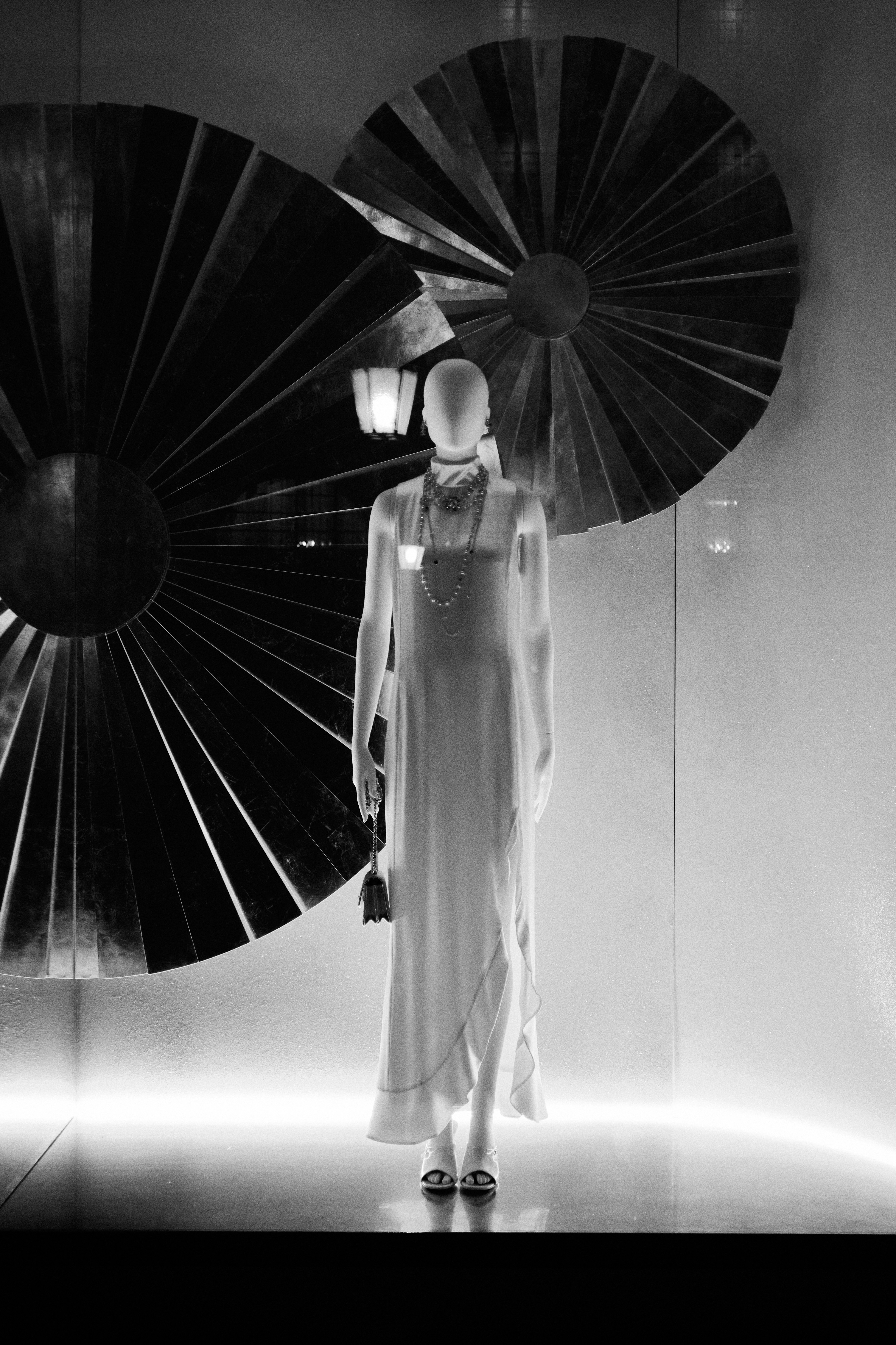 Monochrome Silk: A Dressed Silhouette Beneath Fan-Wedged Light