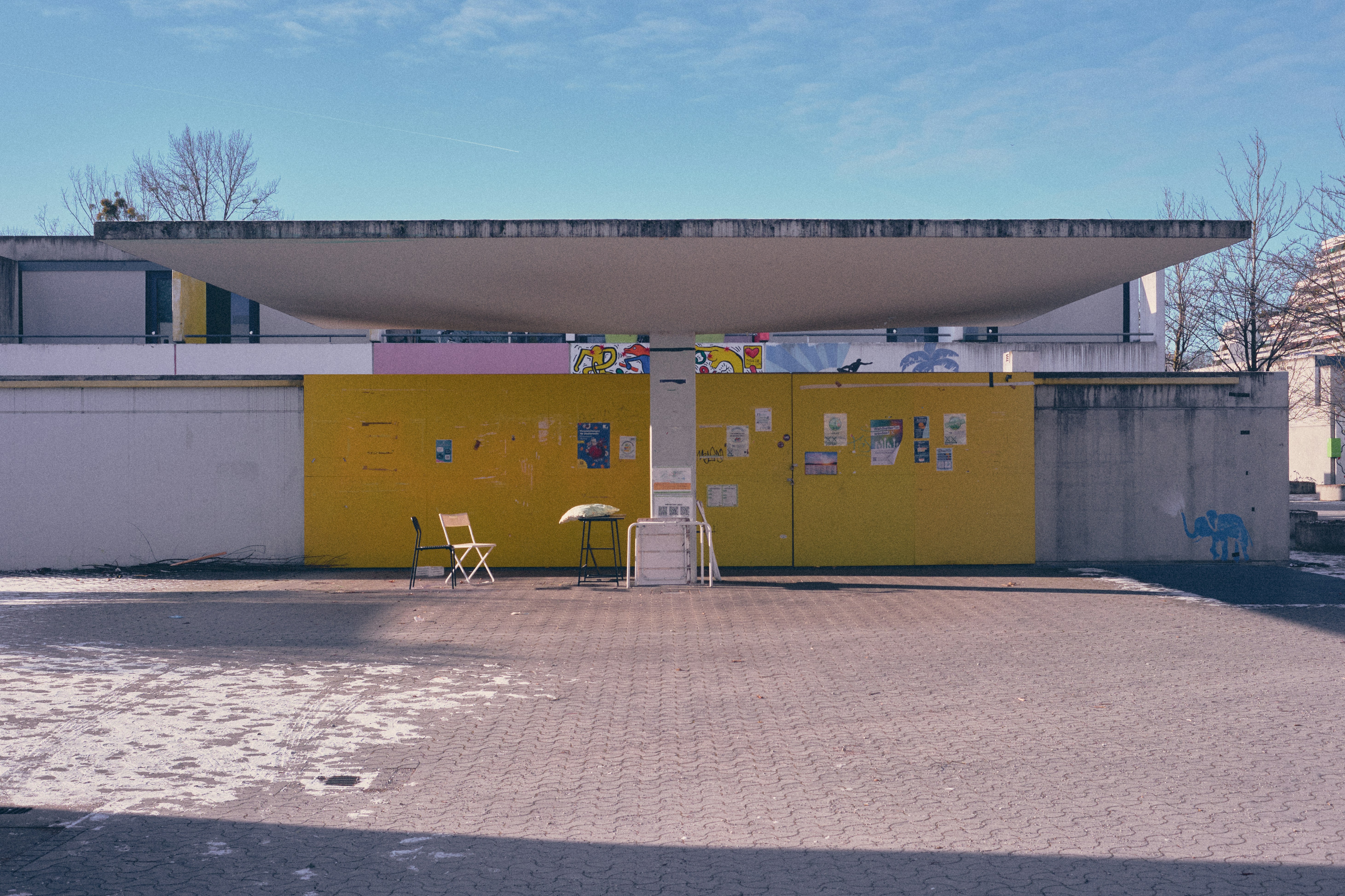 Yellow Wall, Shade Sail, and Quiet Courtyard