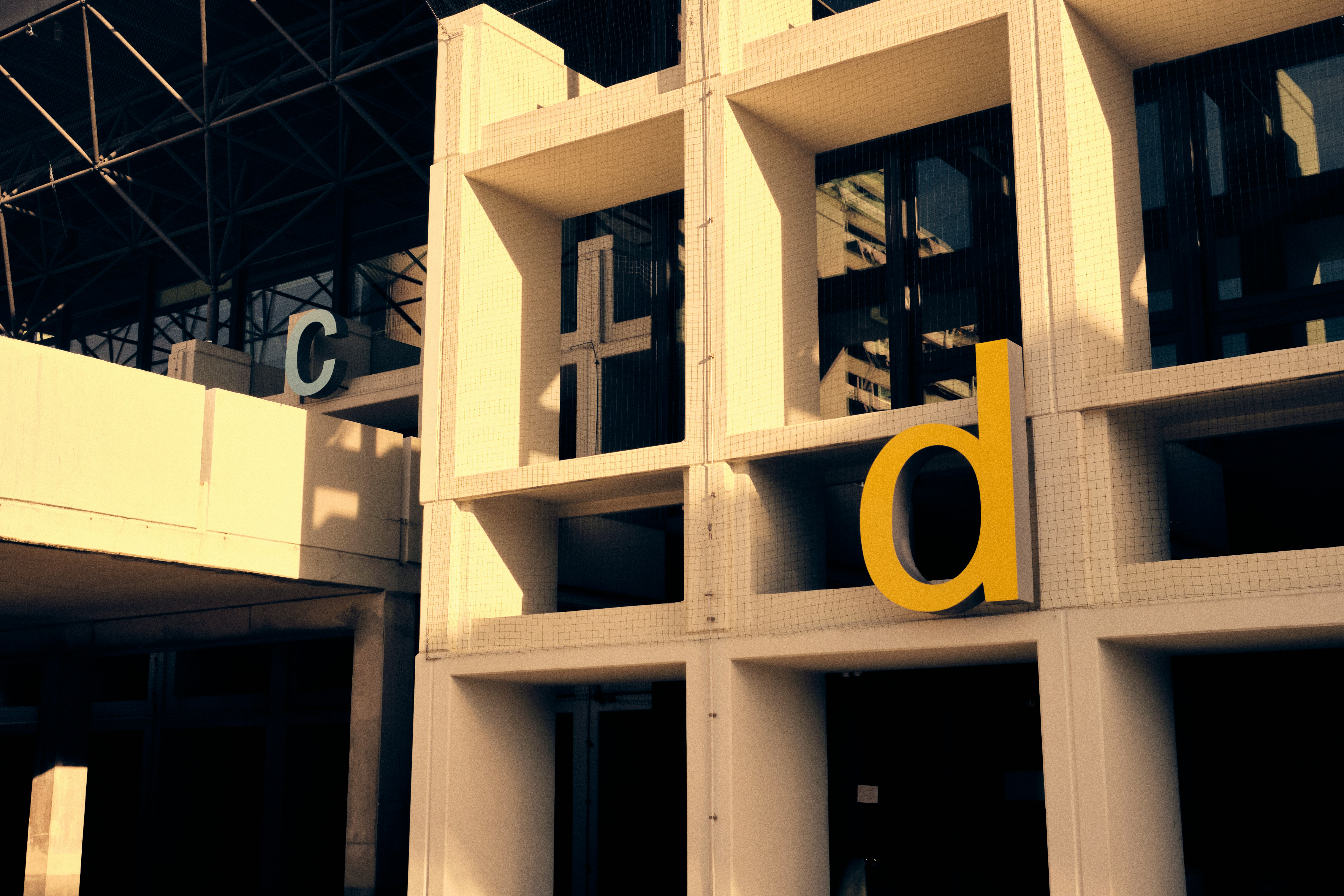 Architectural Letters: A Geometric Facade with Oversized Yellow D