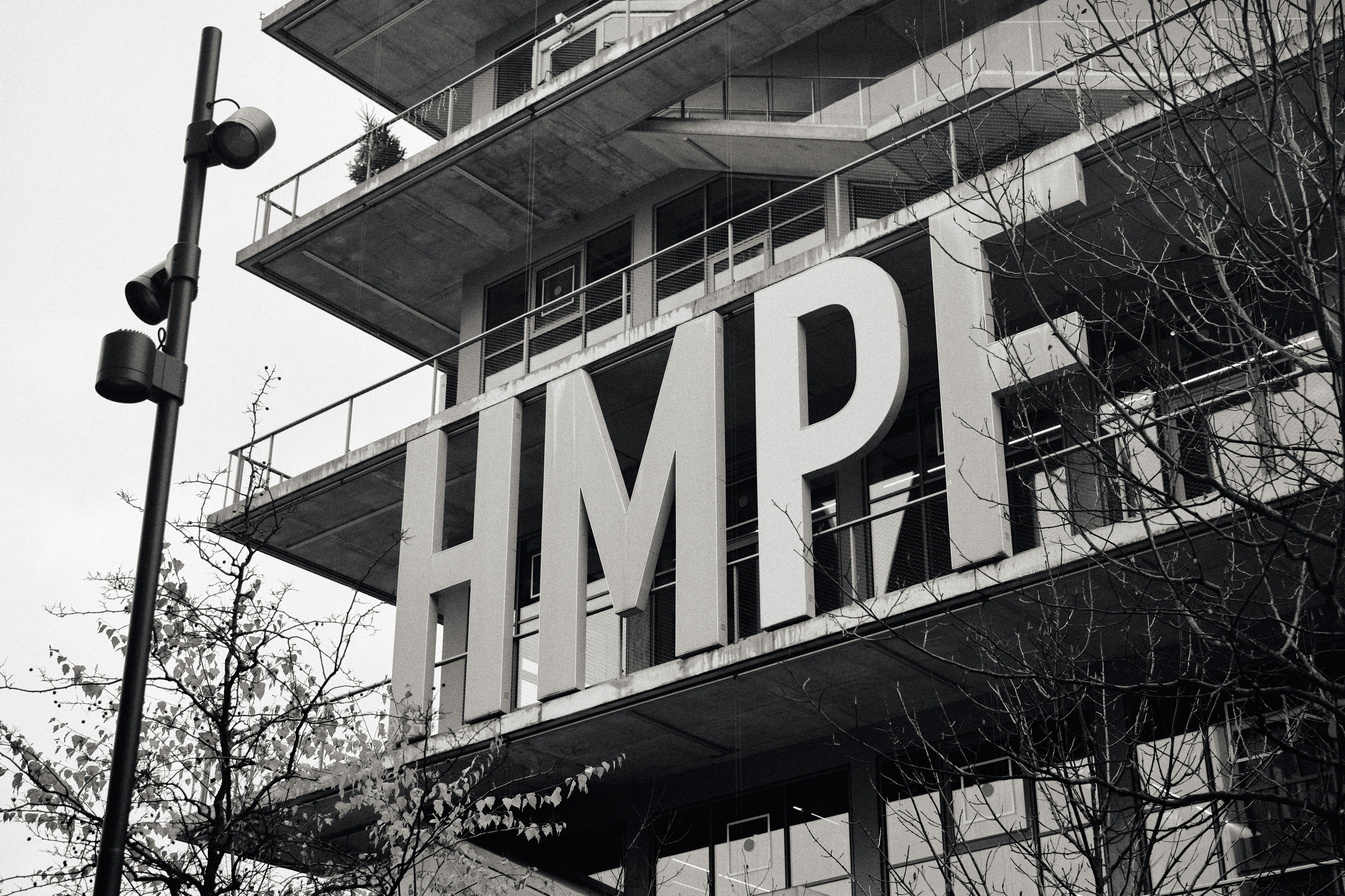 Large hmpf letters on a building facade in monochrome.