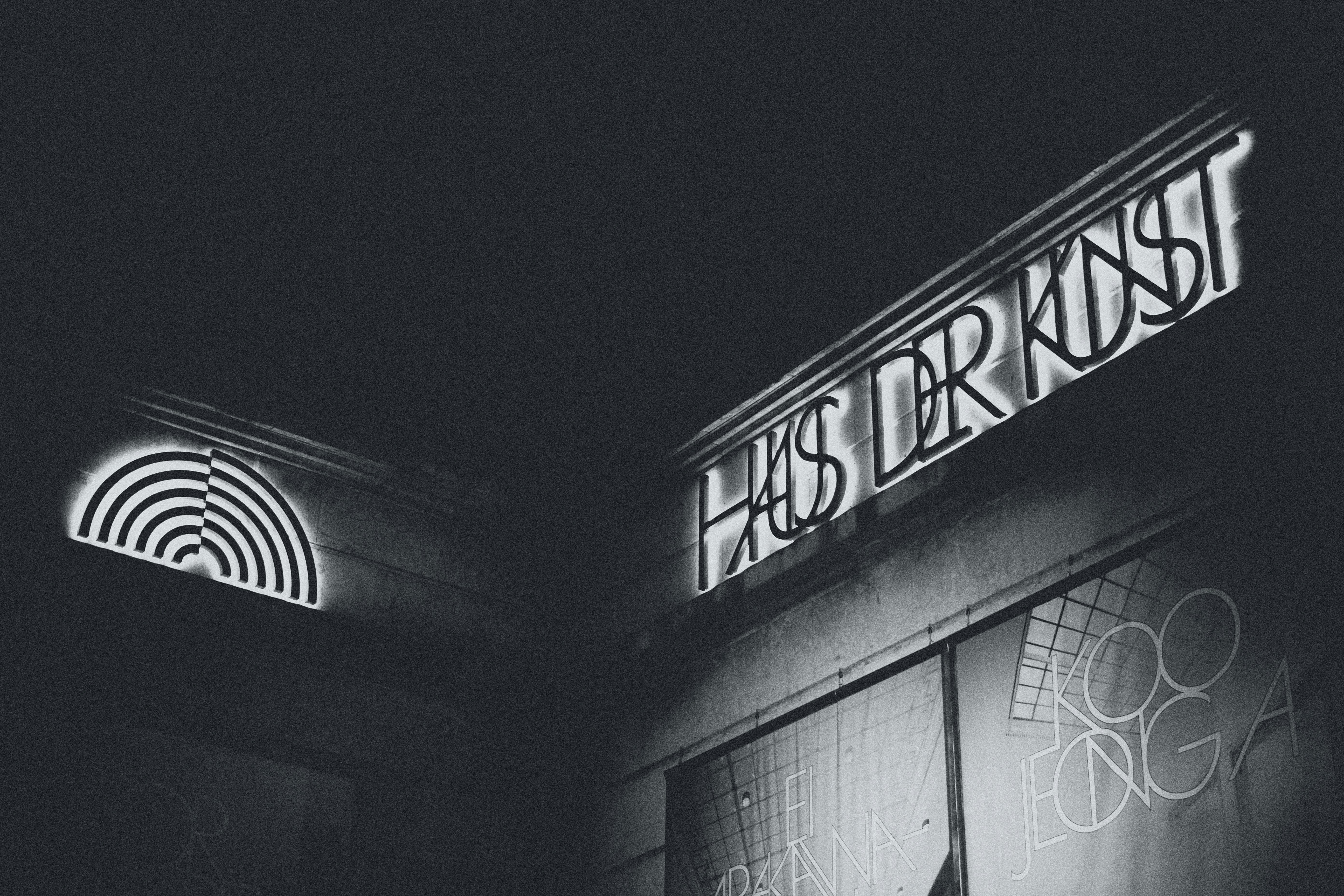 Haus der kunst neon sign and striped light in darkness.
