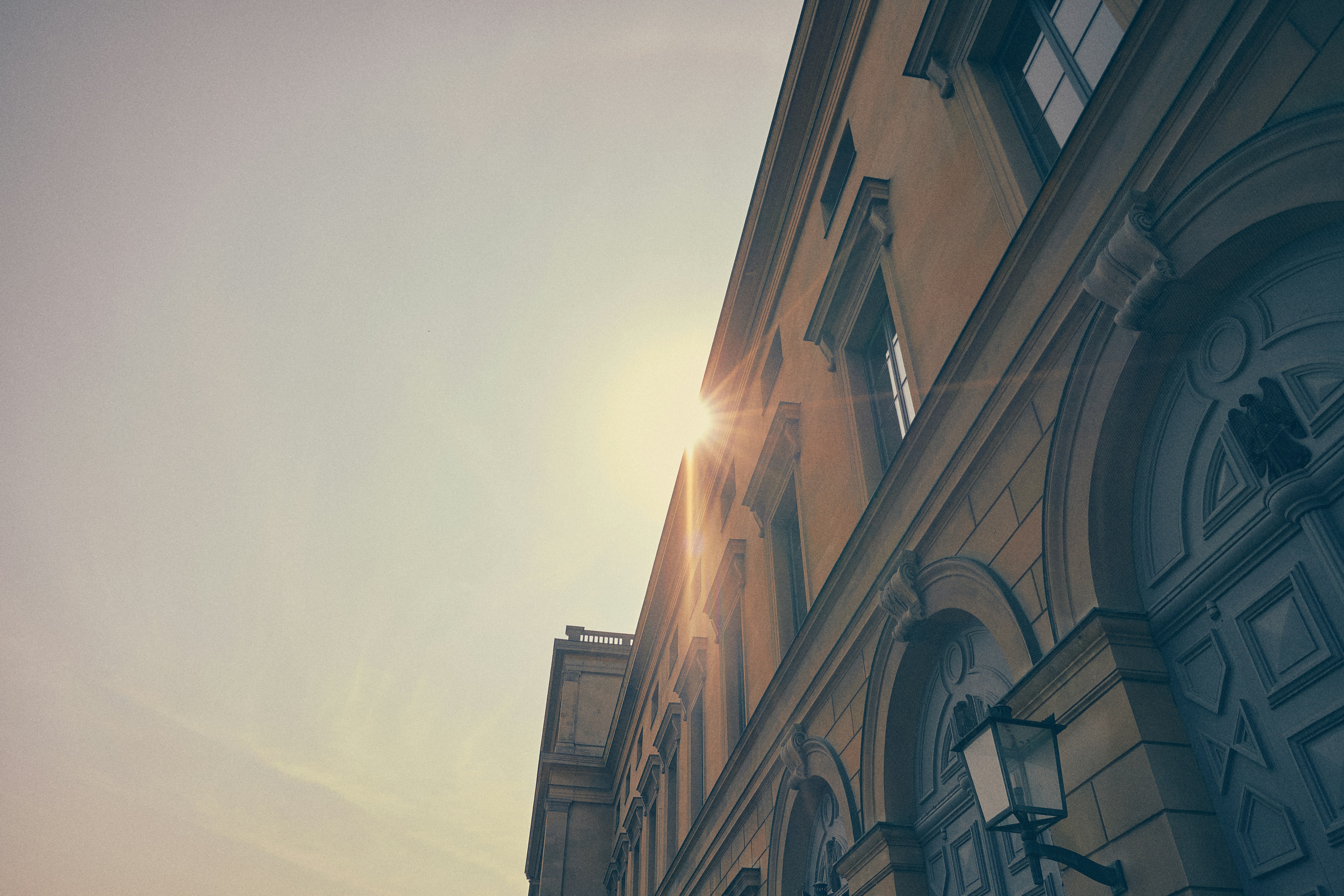 Sunburst Over Intricate Facade: An Evening Light on Classical Architecture
