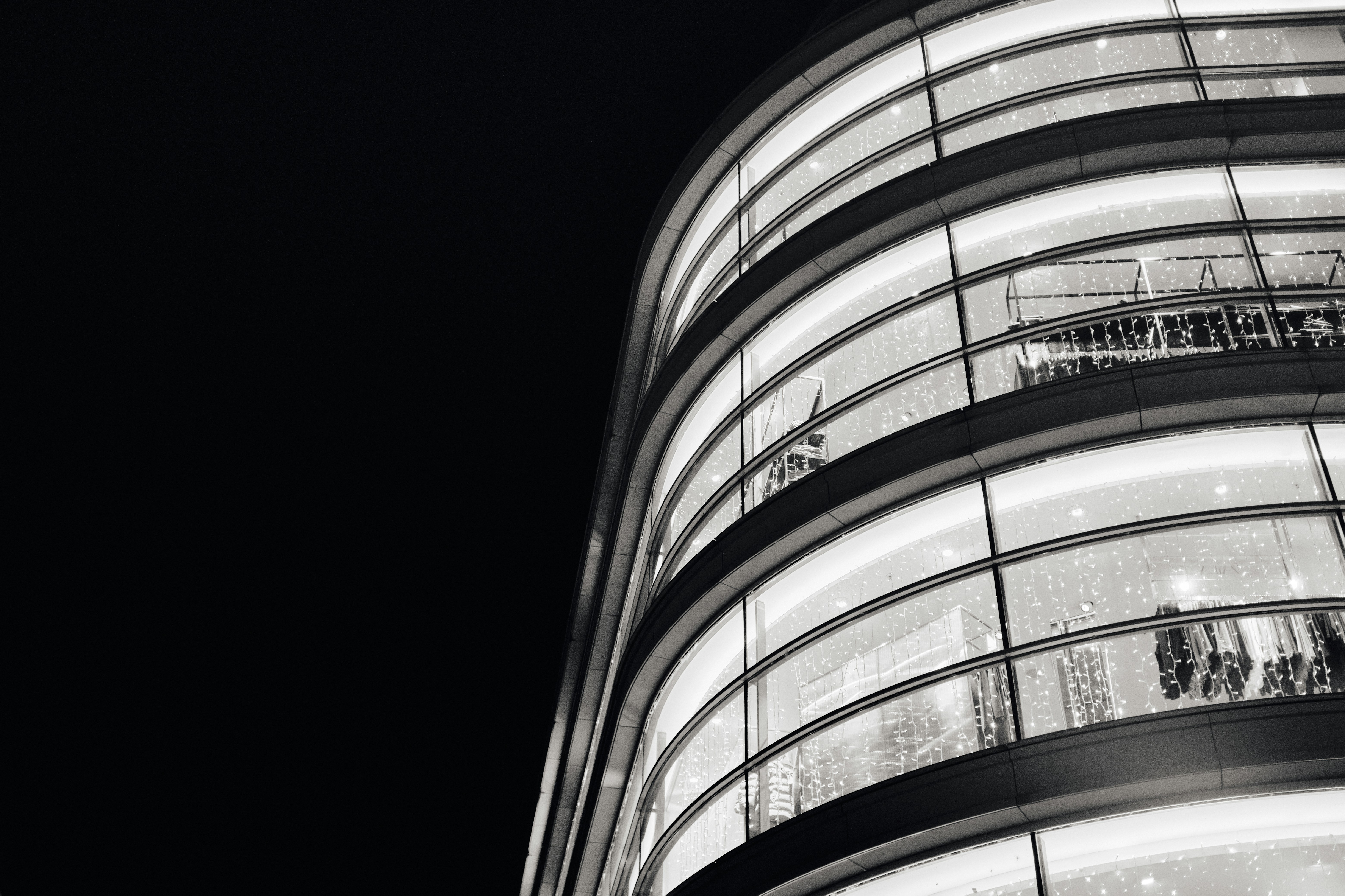 Neon Rolls: Curved Glass Facade Cut by Night