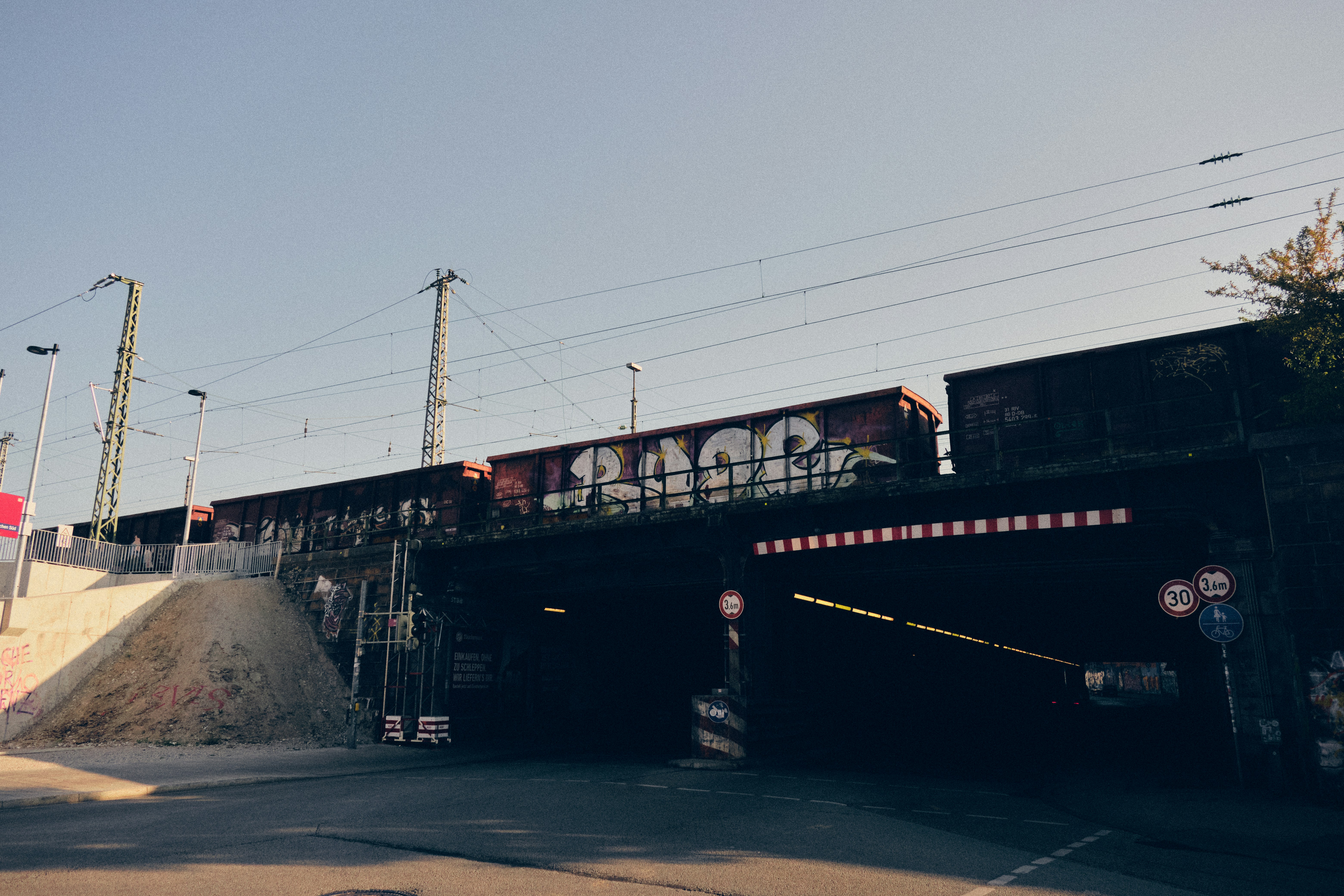 Railyard Underpass: Graffiti, Rails, and Dim Light