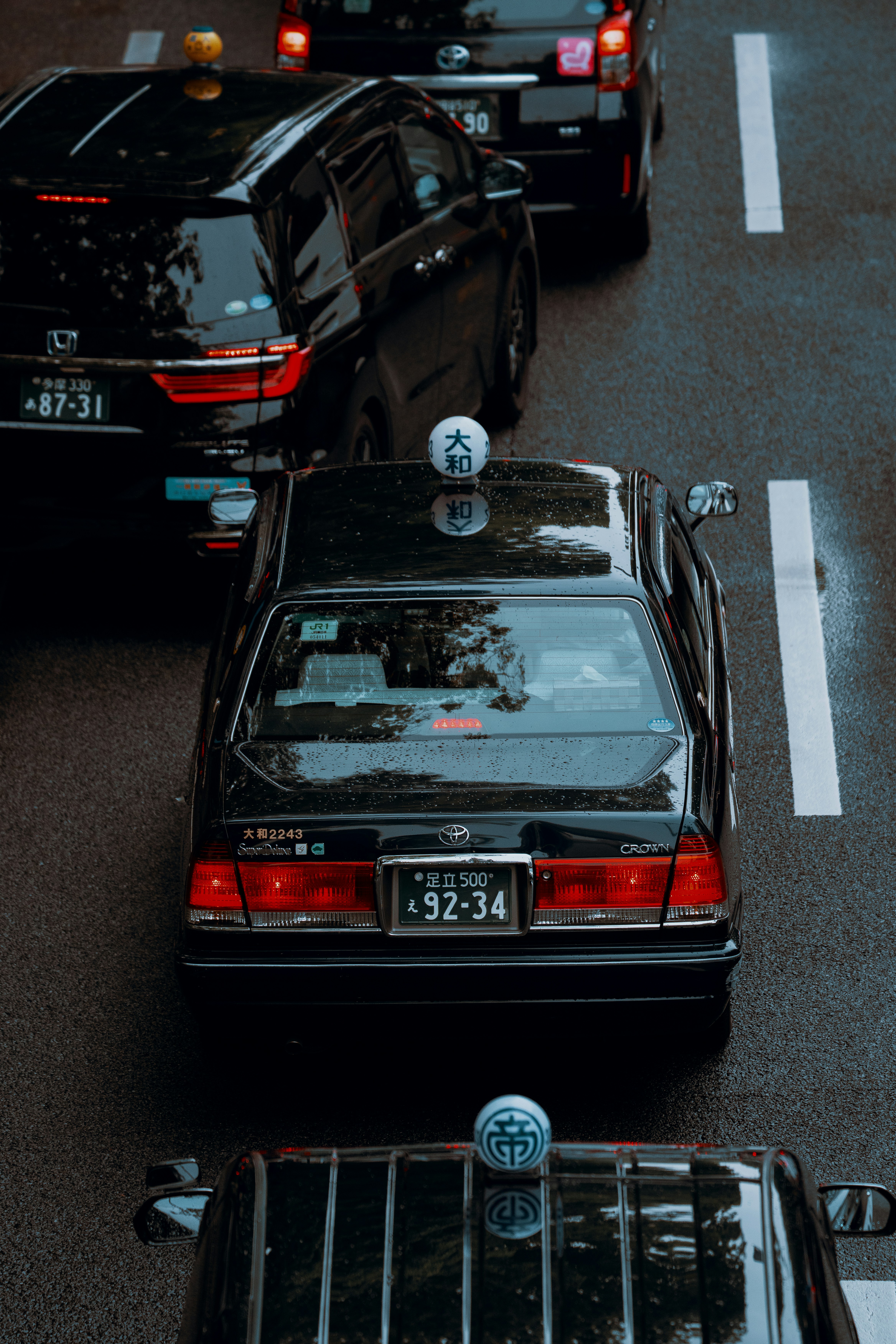 Midnight Taxi Parade: A Lineup of Quiet Authority on a Rainy Street
