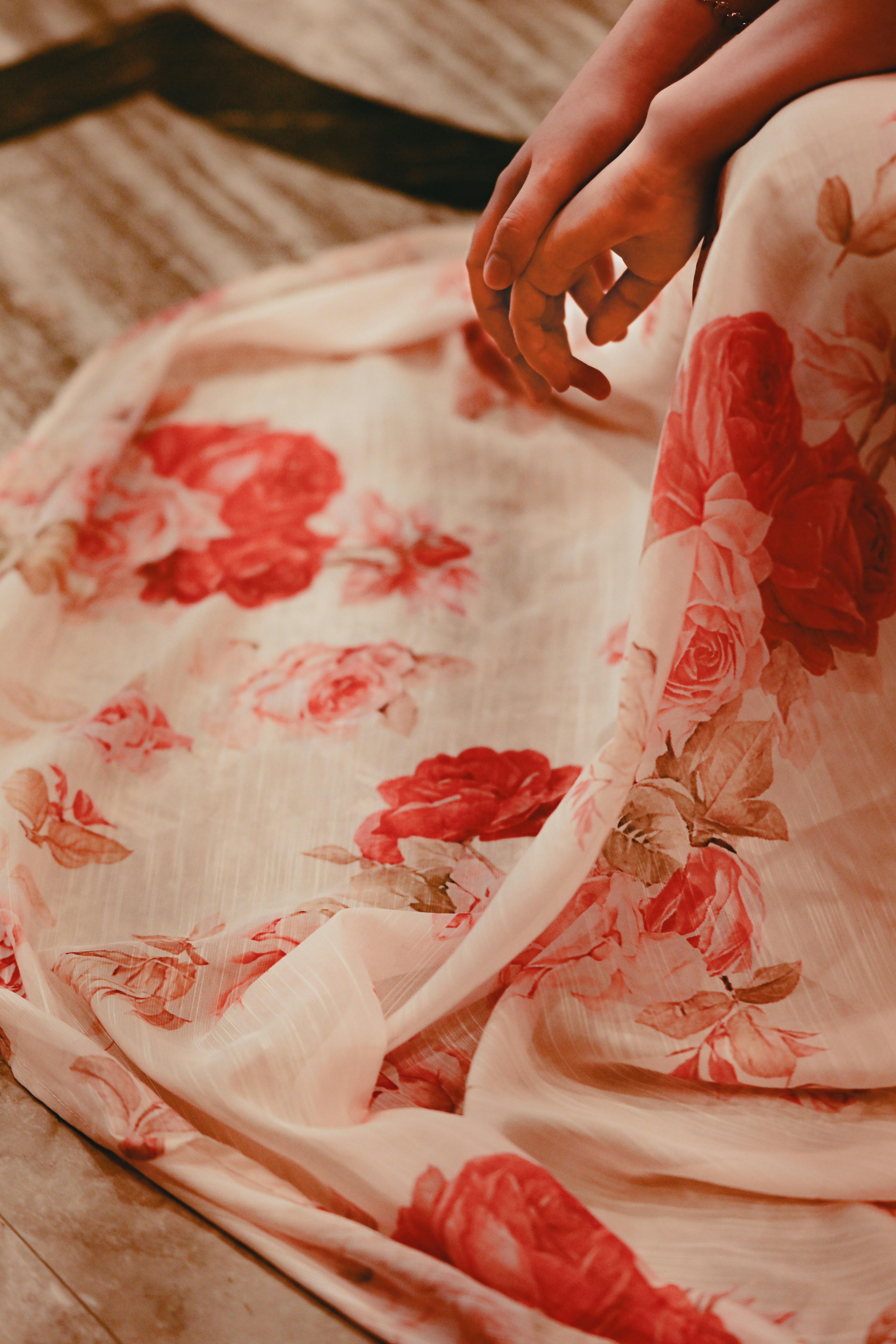 Hands Meet Floral Silhouette: A Quiet Moment on Raspberry Linen
