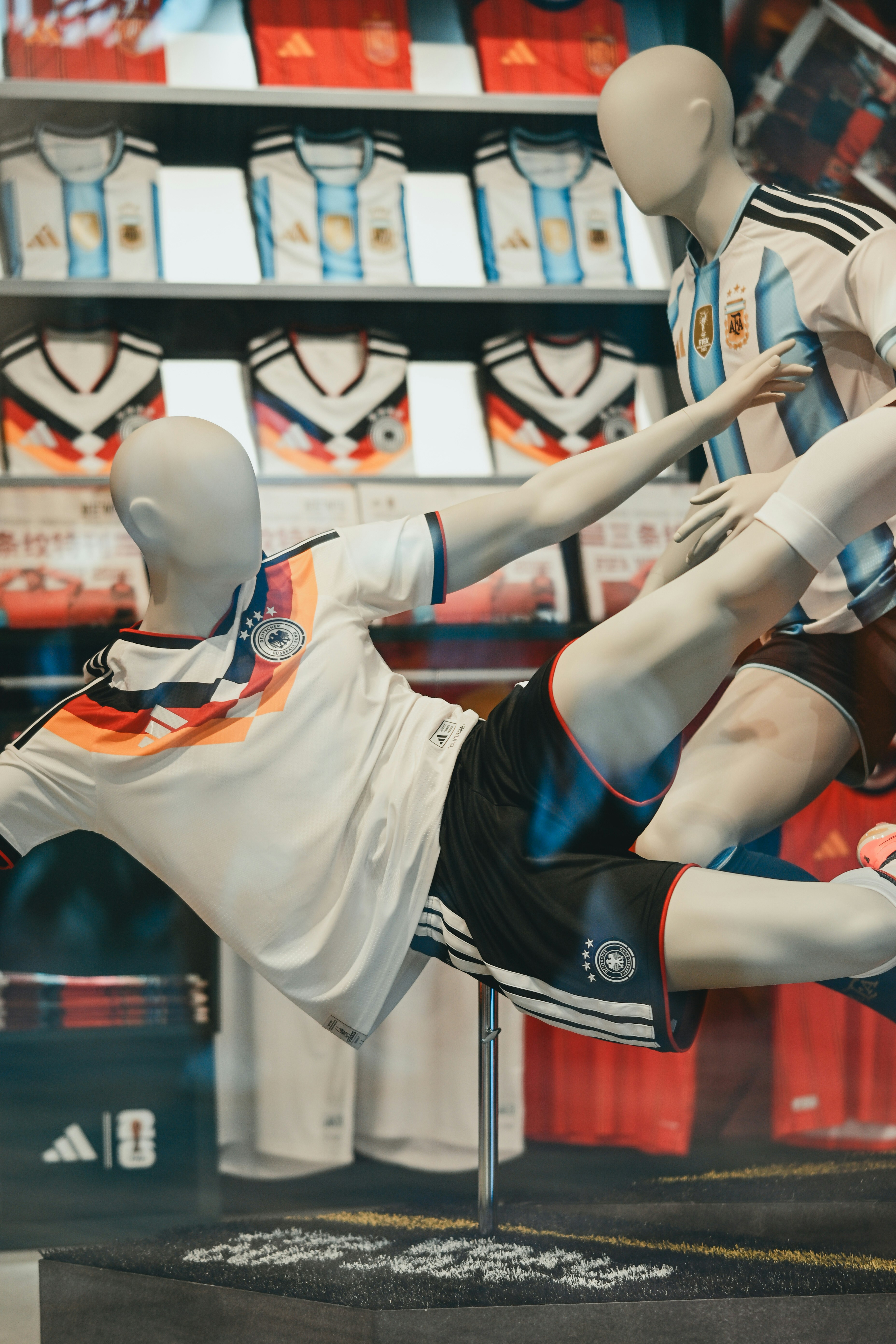 German and argentinian soccer jerseys displayed on dynamic mannequins.
