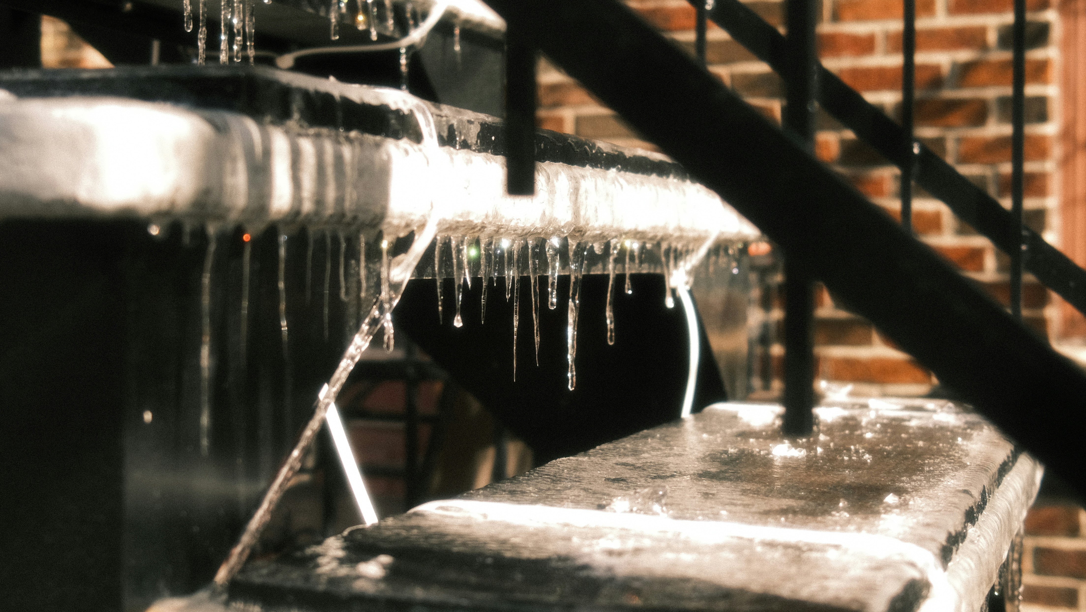Icicles over a frozen stairwell: urban winter detail