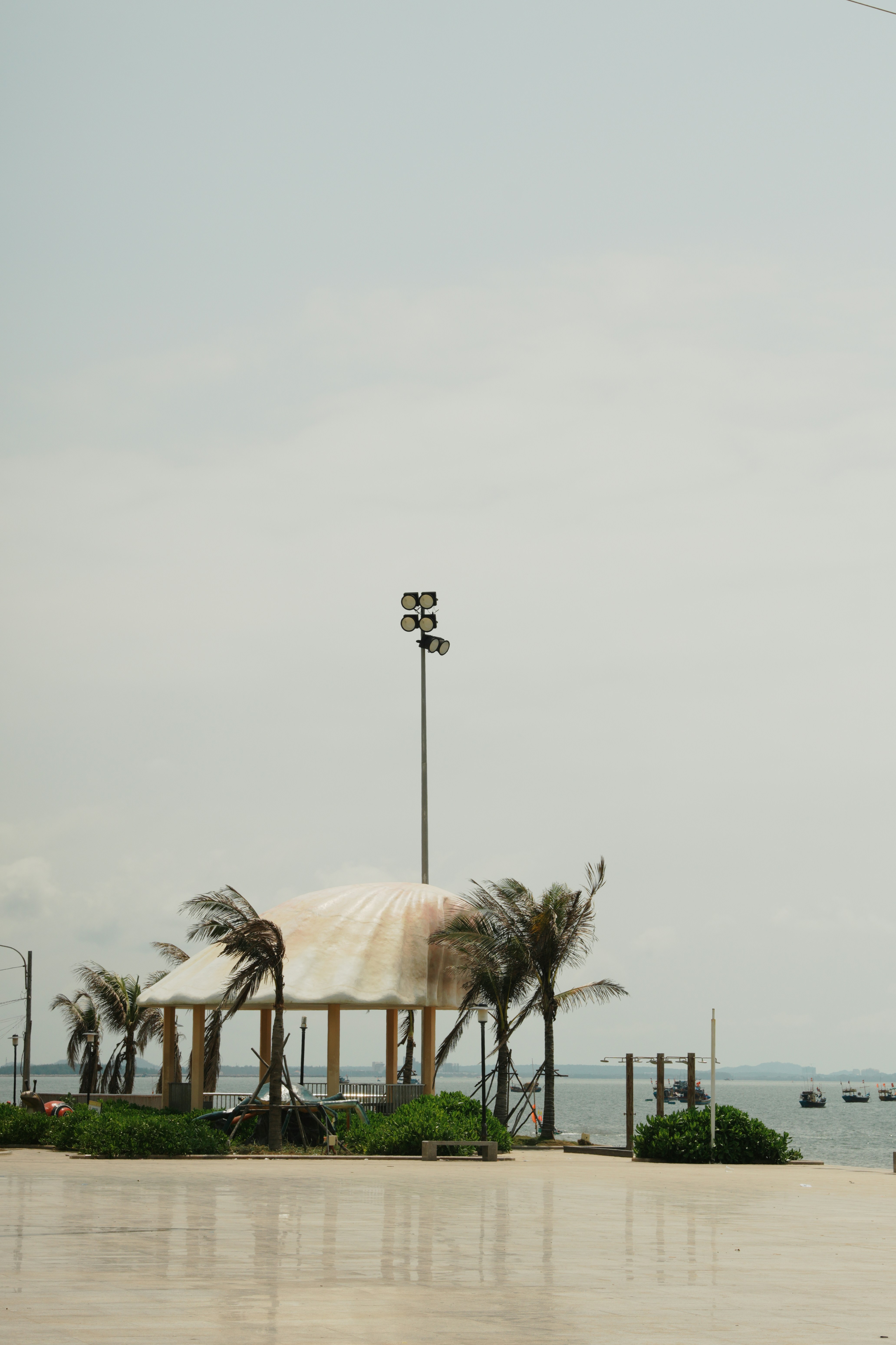 Beachside Gazebo Under a Wide Sky with Palm Fronds