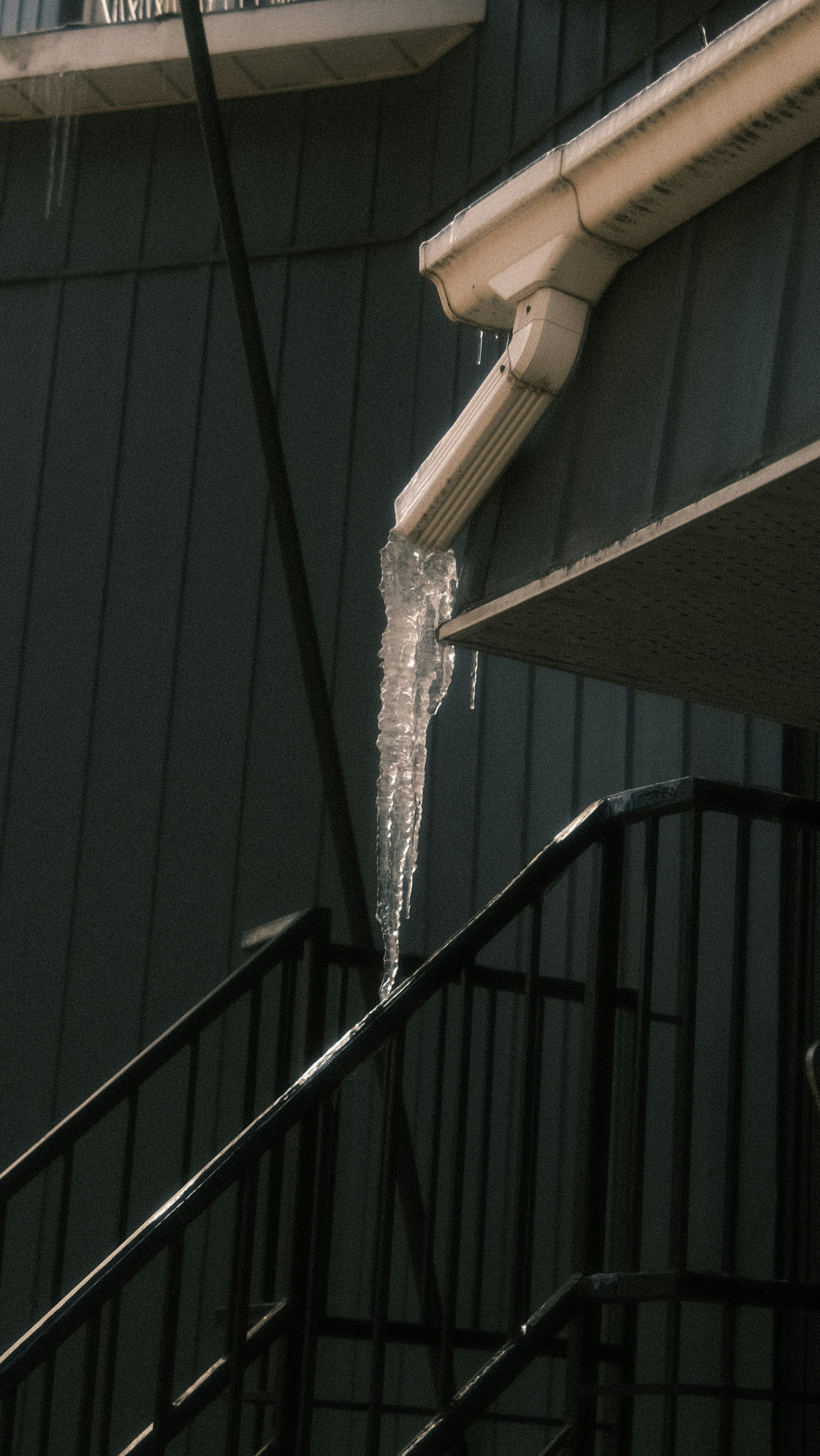 Icicle Cascade from a Roof Gutter Overlook