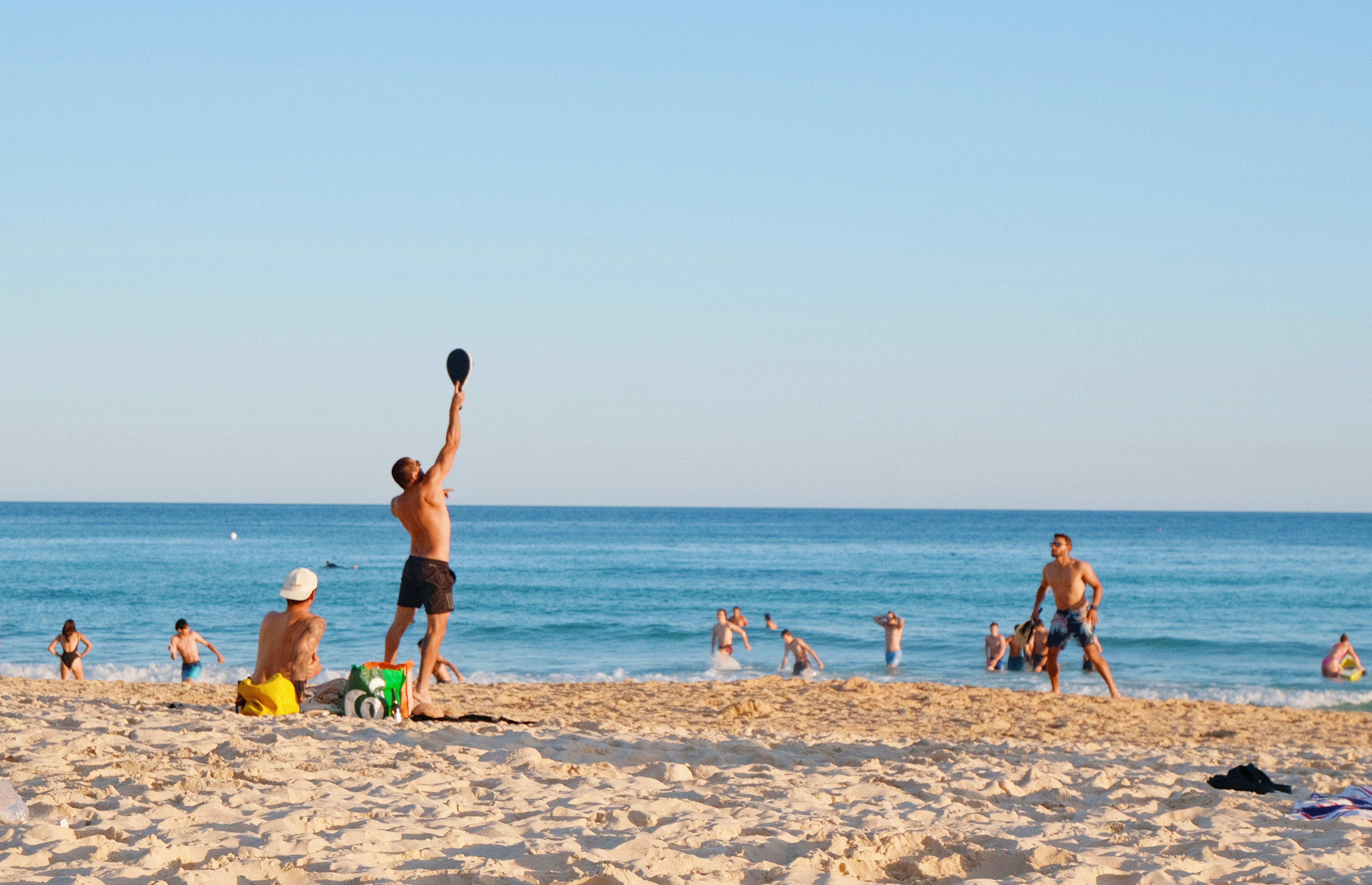 Sunlit Beach Volleyball: A Moment of Jump and Reach
