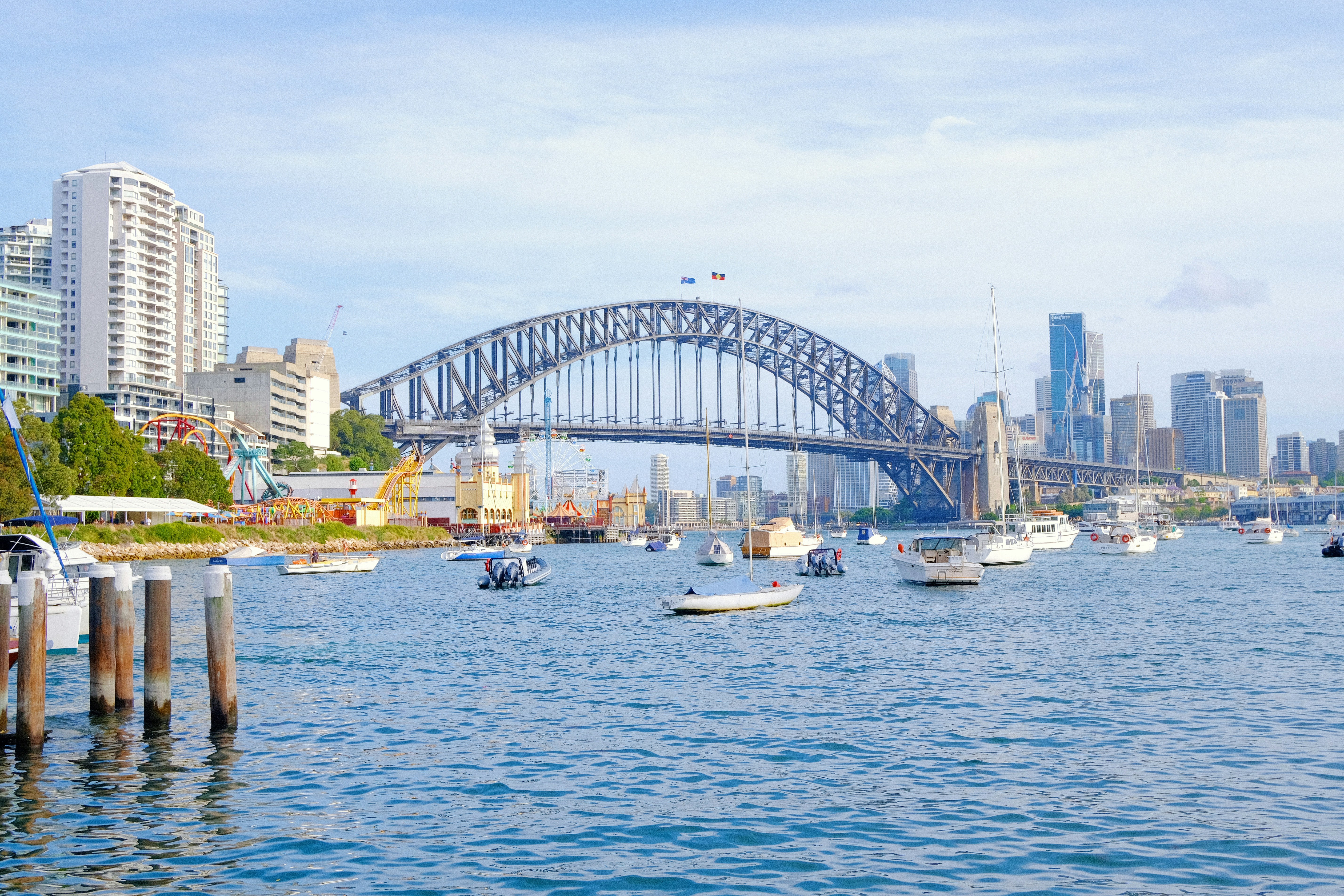 Sydney harbour bridge, boats, and city skyline.
