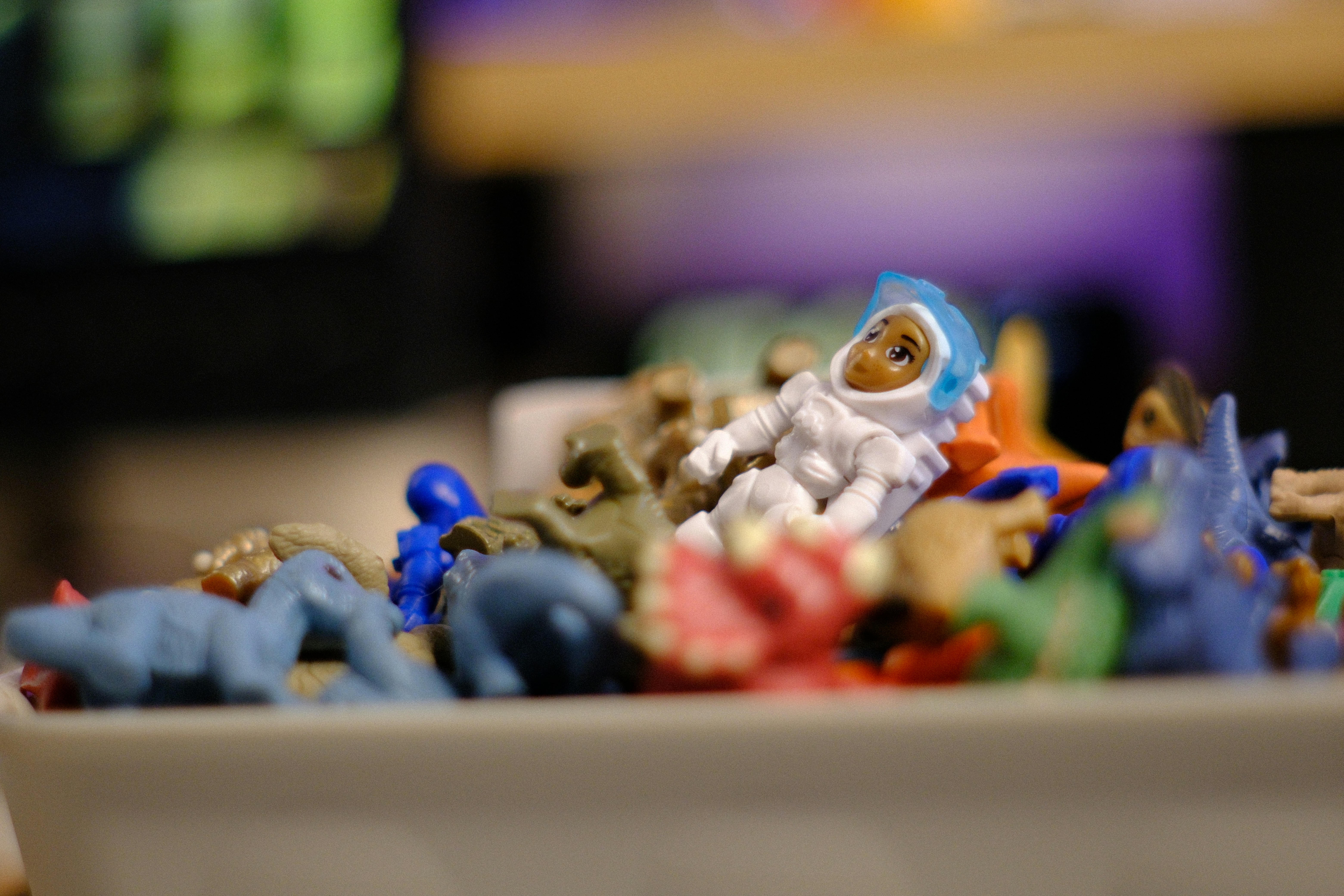 Tiny Astronaut Amid a Colorful Toy Landscape