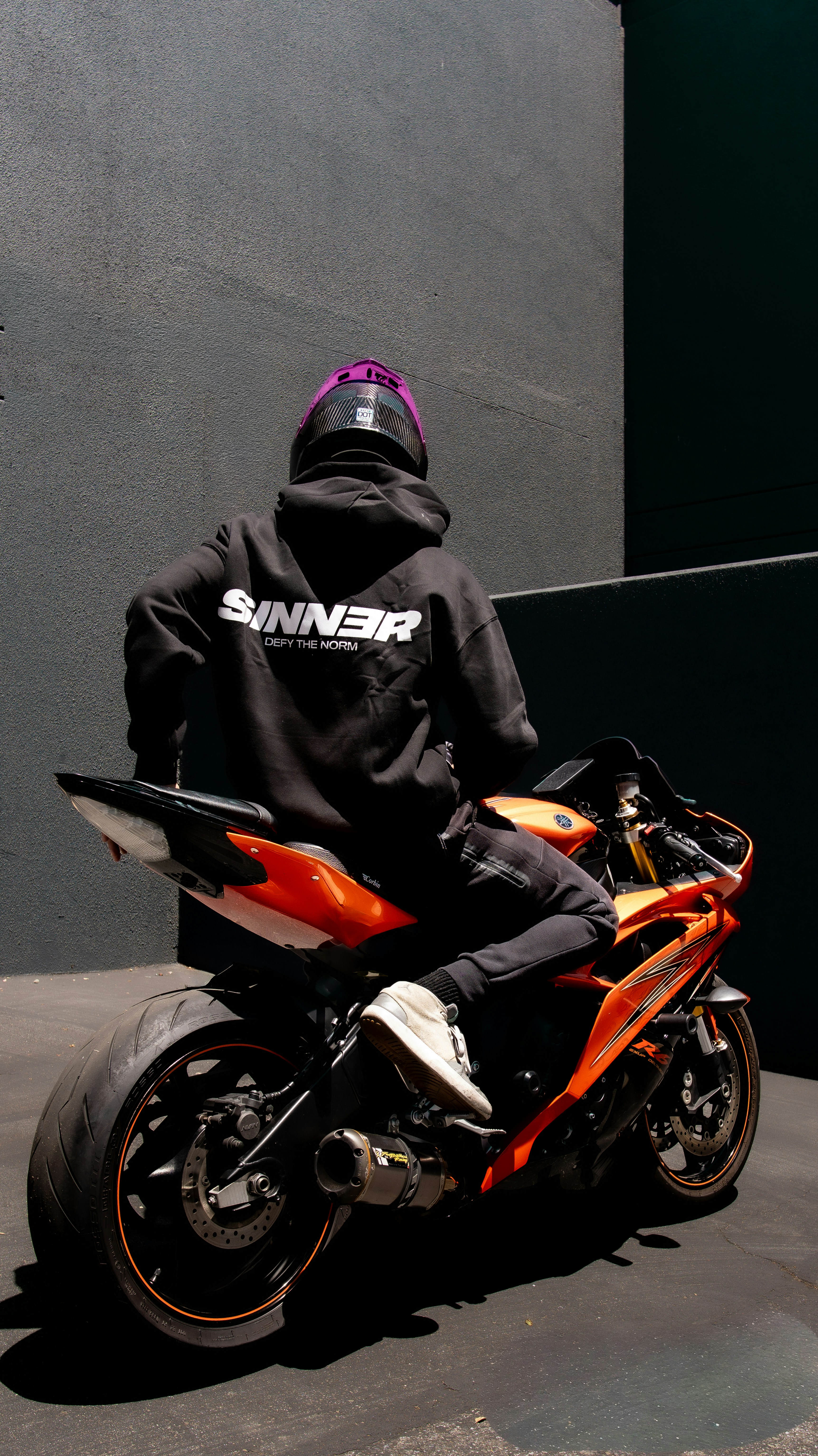 Rider in Neon Armor: A Sunset Spin on the Orange Machine