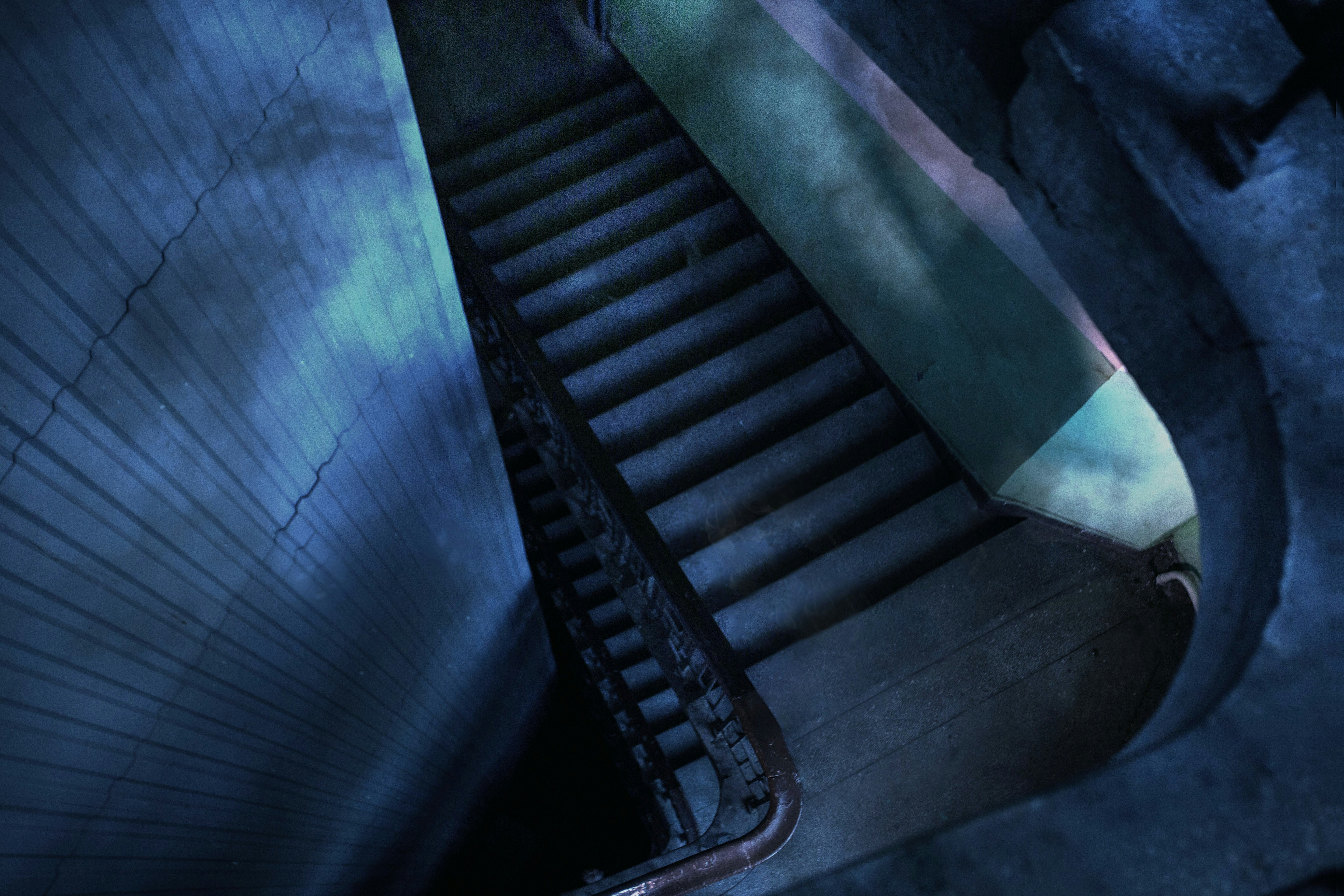 Chiaroscuro Descent: Neon Stairwell in Blue Concrete