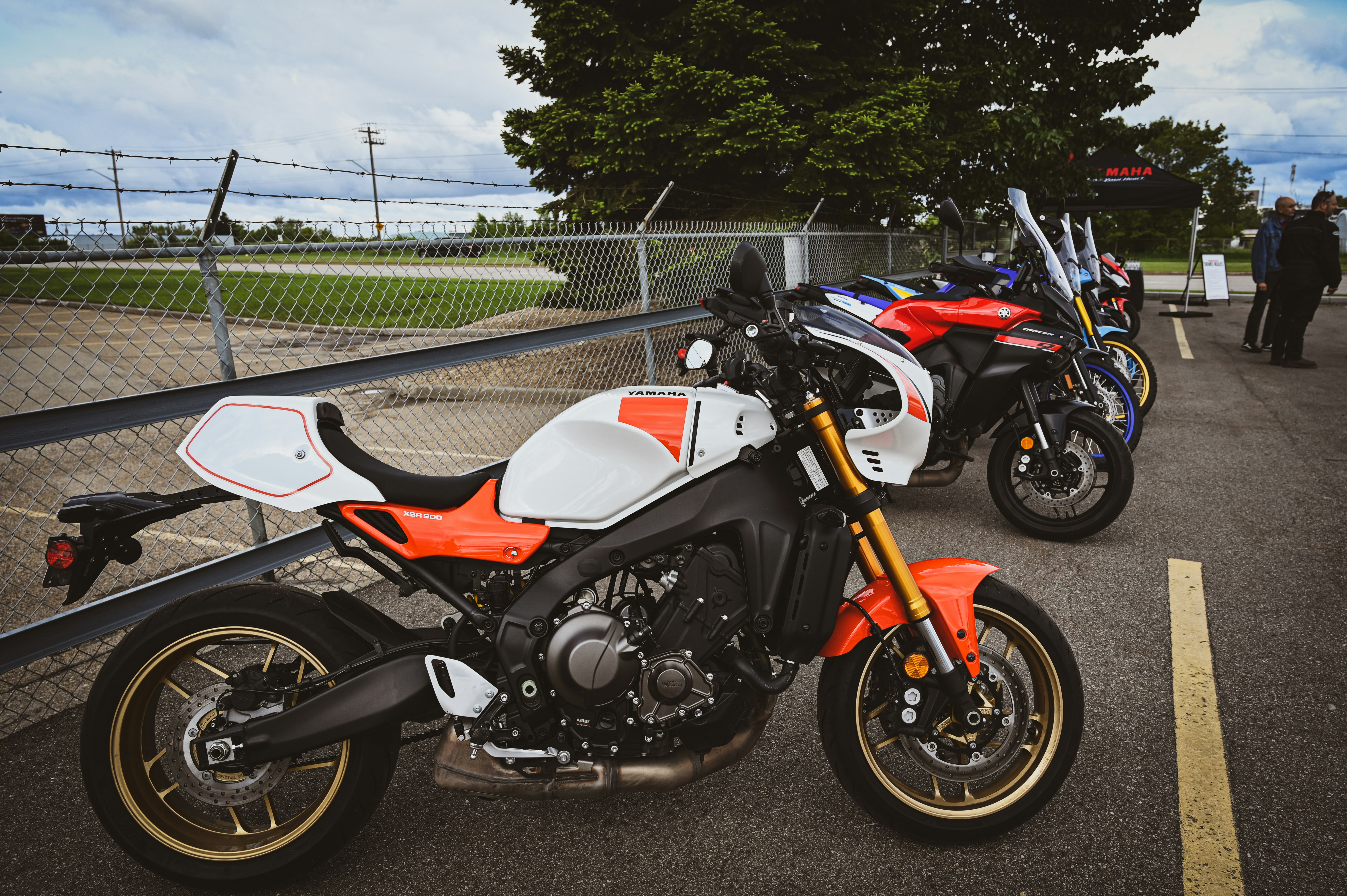 Bright Orange Accent on a Row of Modern Motorcycles