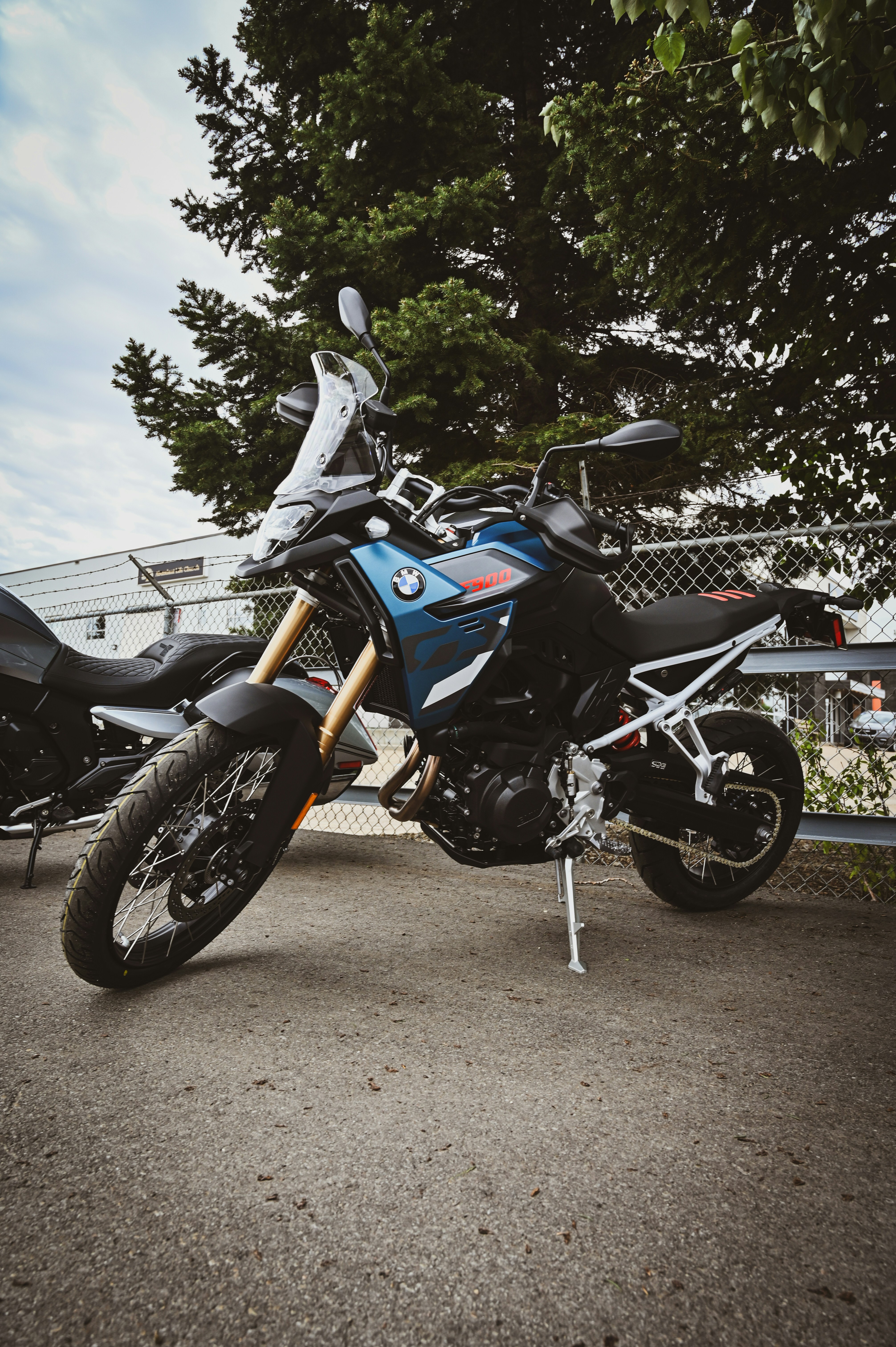 Blue BMW R1200-inspired adventure: a street-parked dual-sport under a cloudy sky