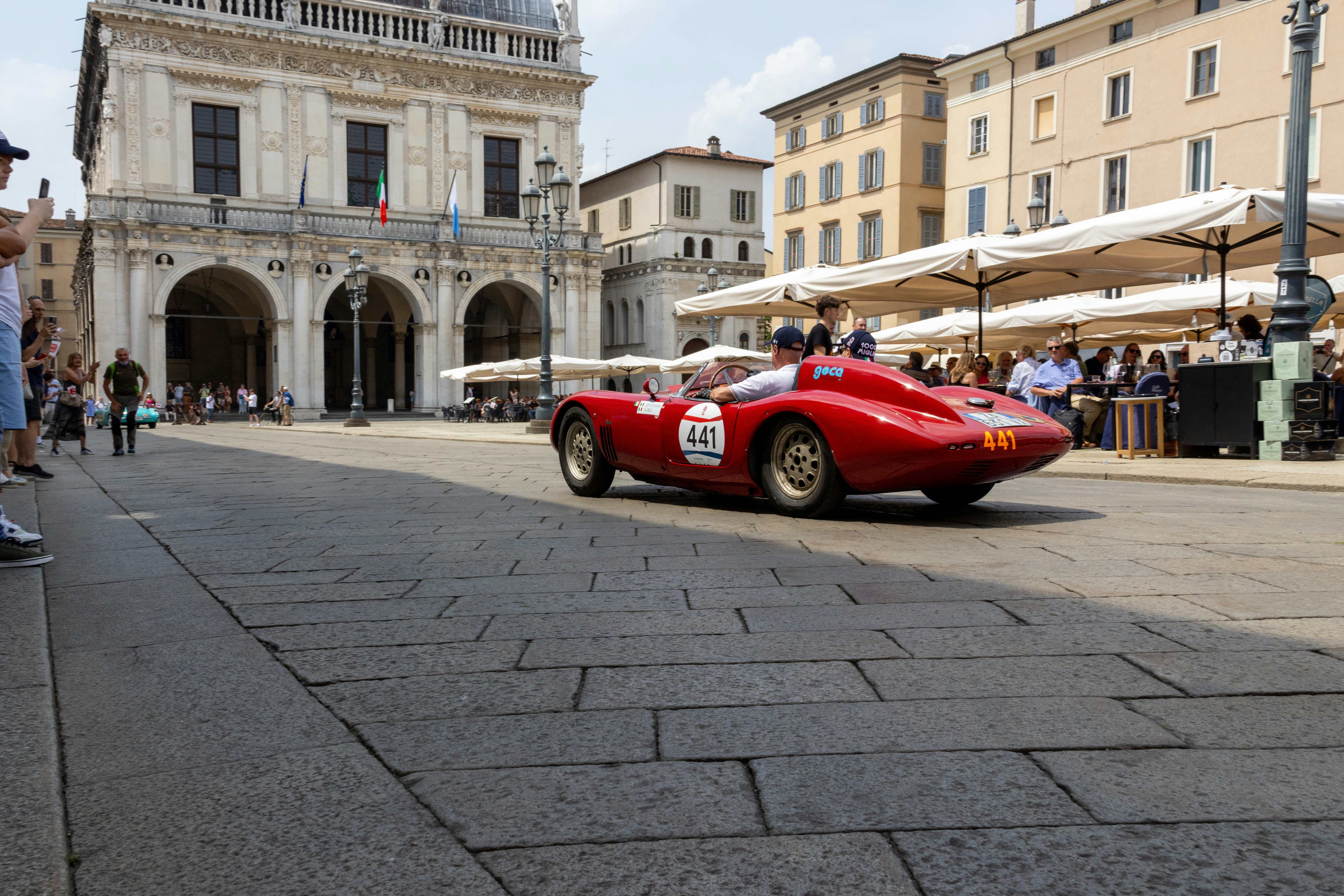Red Racer in a European Square: Classic Car Meets Historic Arcades