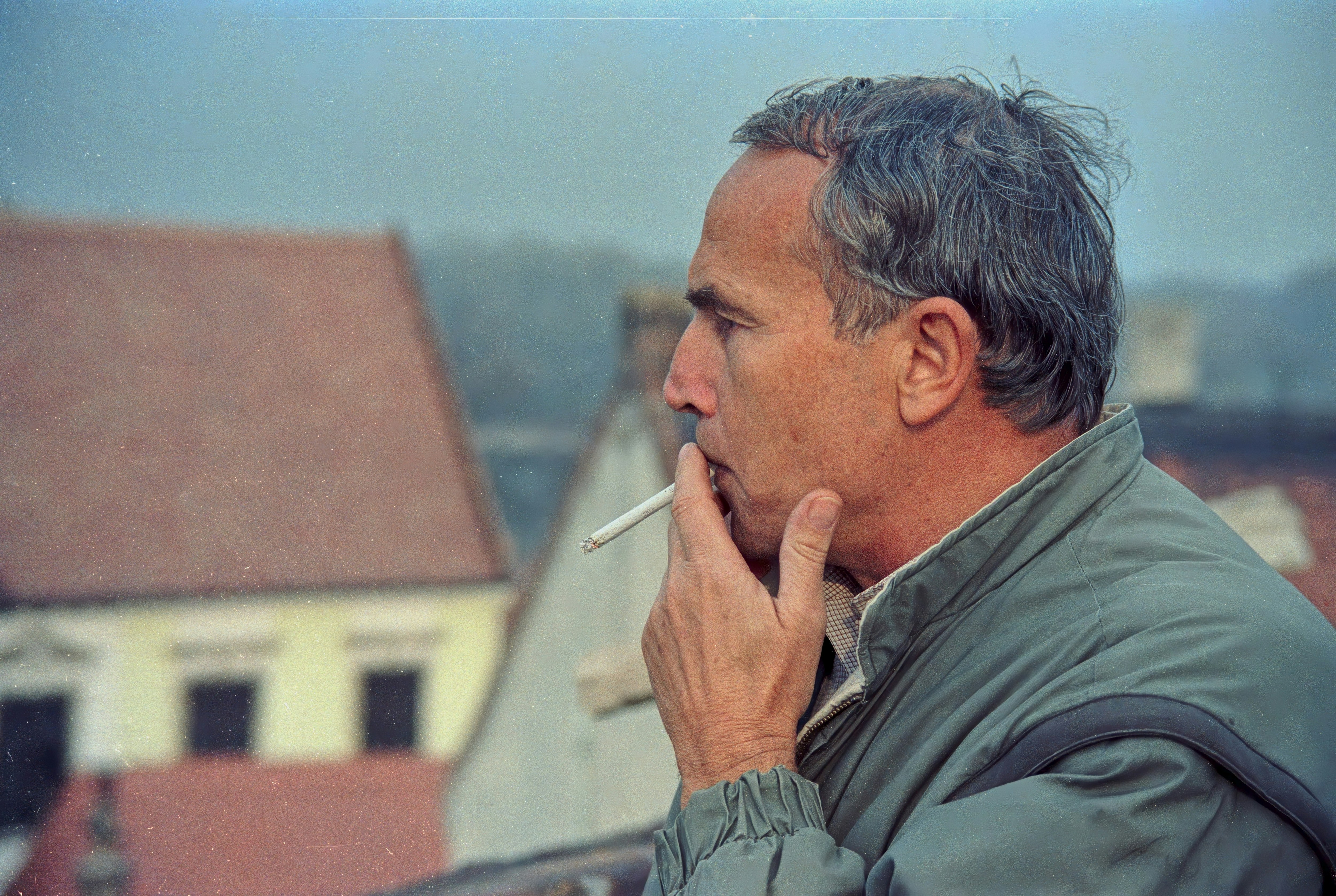 Smoke and Cityscape: A contemplative moment on a rooftop