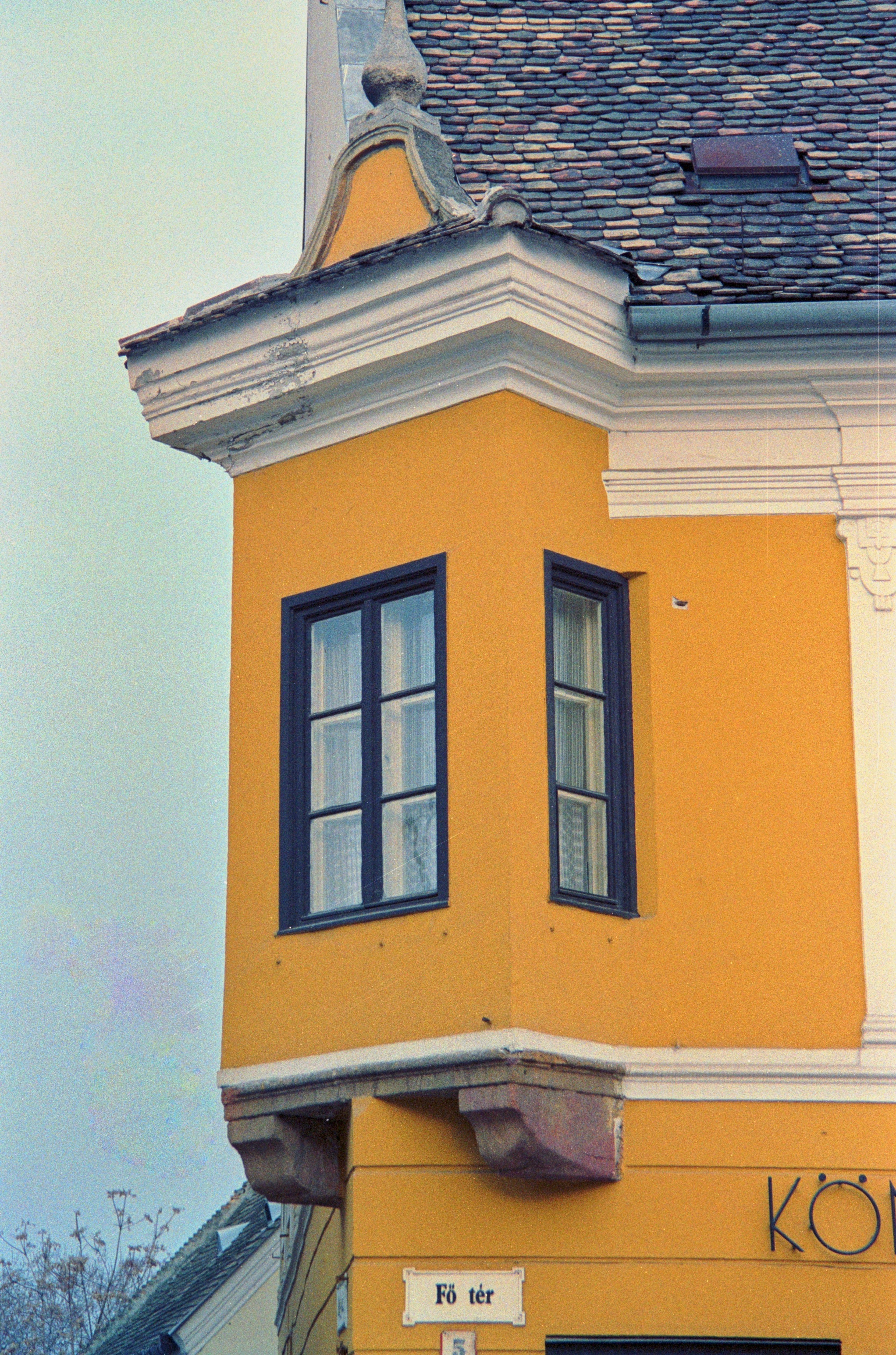 Sunlit Orange Facade: Corner Tower Detail with Roofline