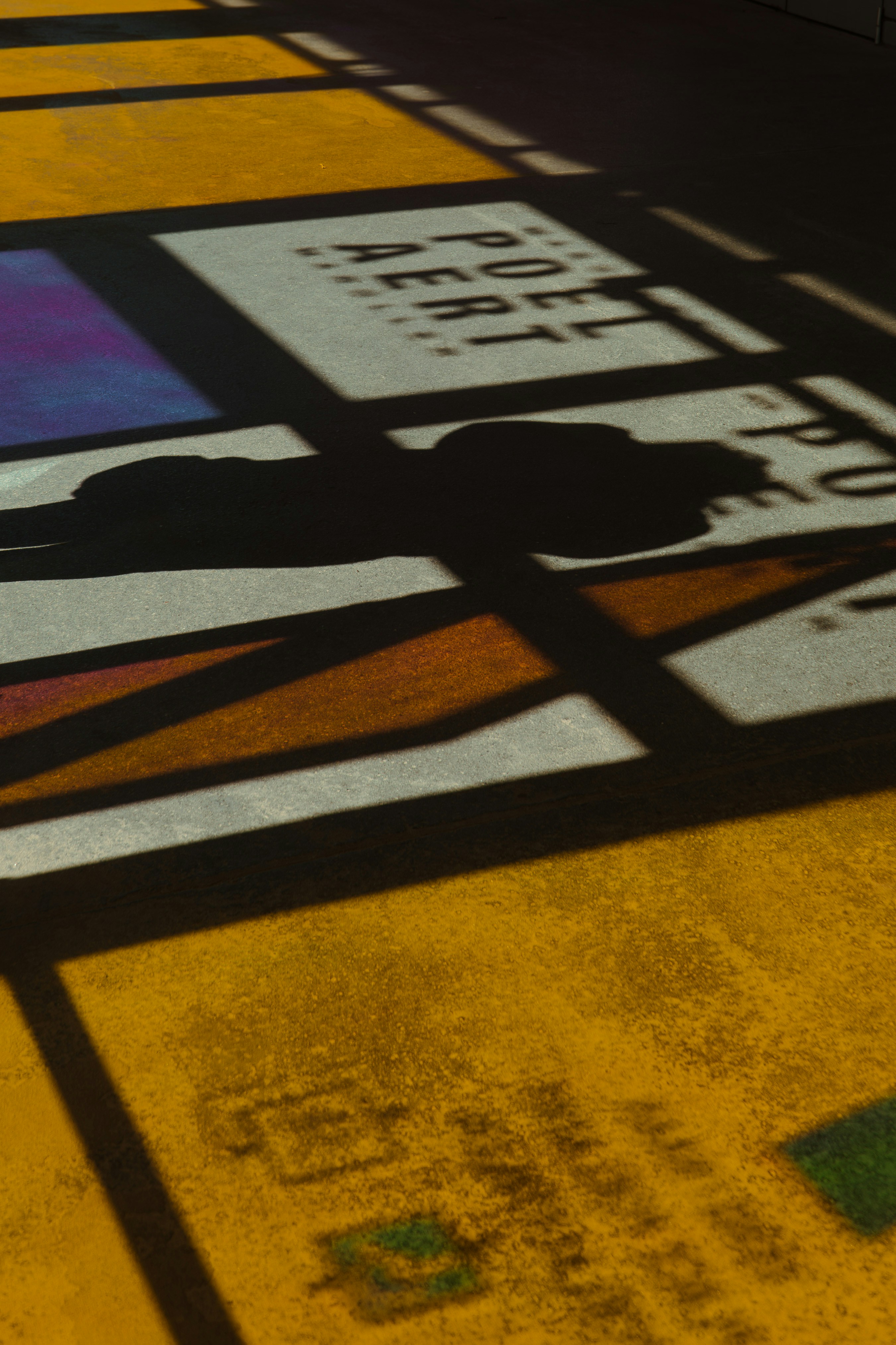 Shadowed silhouette crossing through colored glass panels
