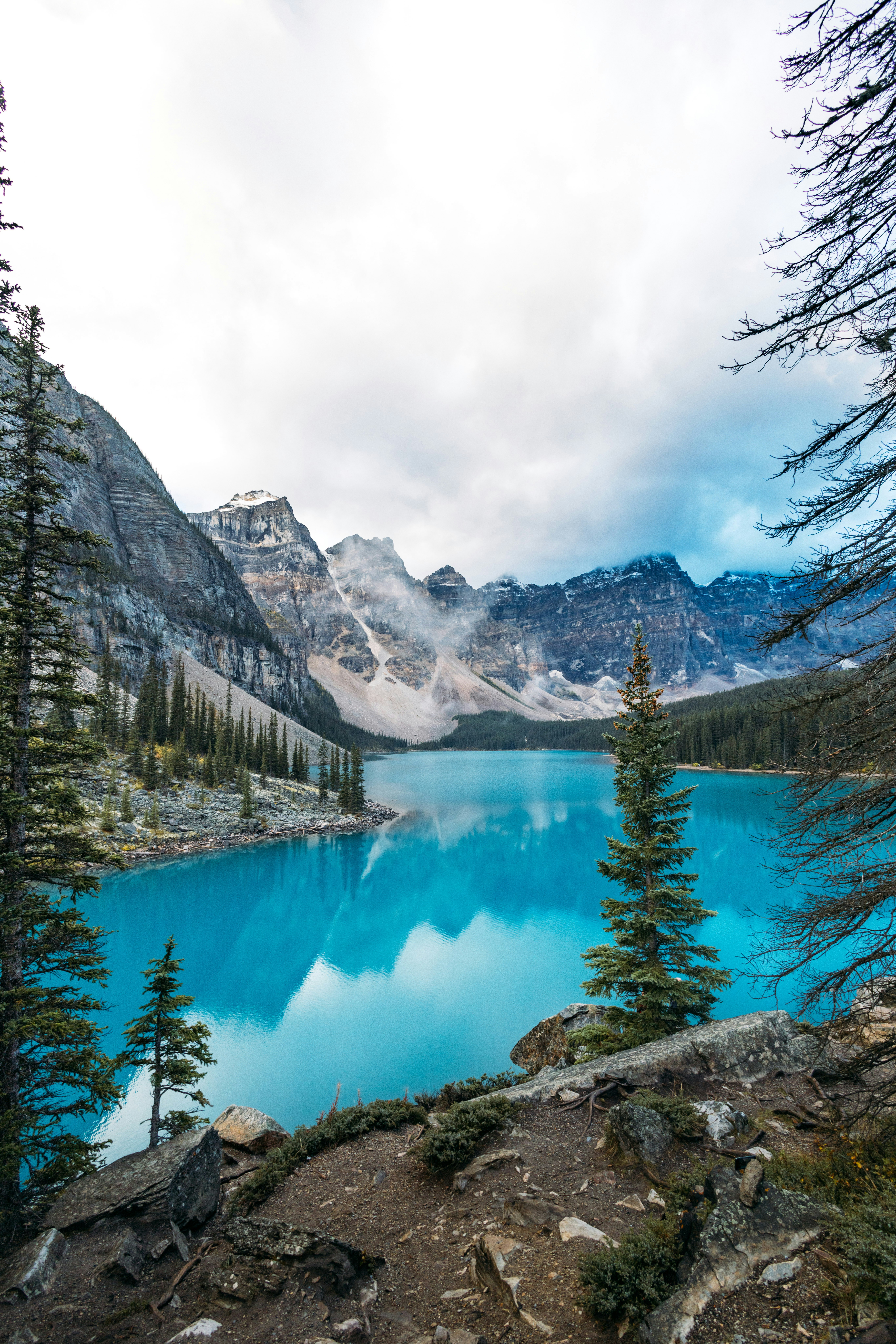 Turquoise Heart of the Valley: A Lake Surrounded by Snow-dusted Peaks