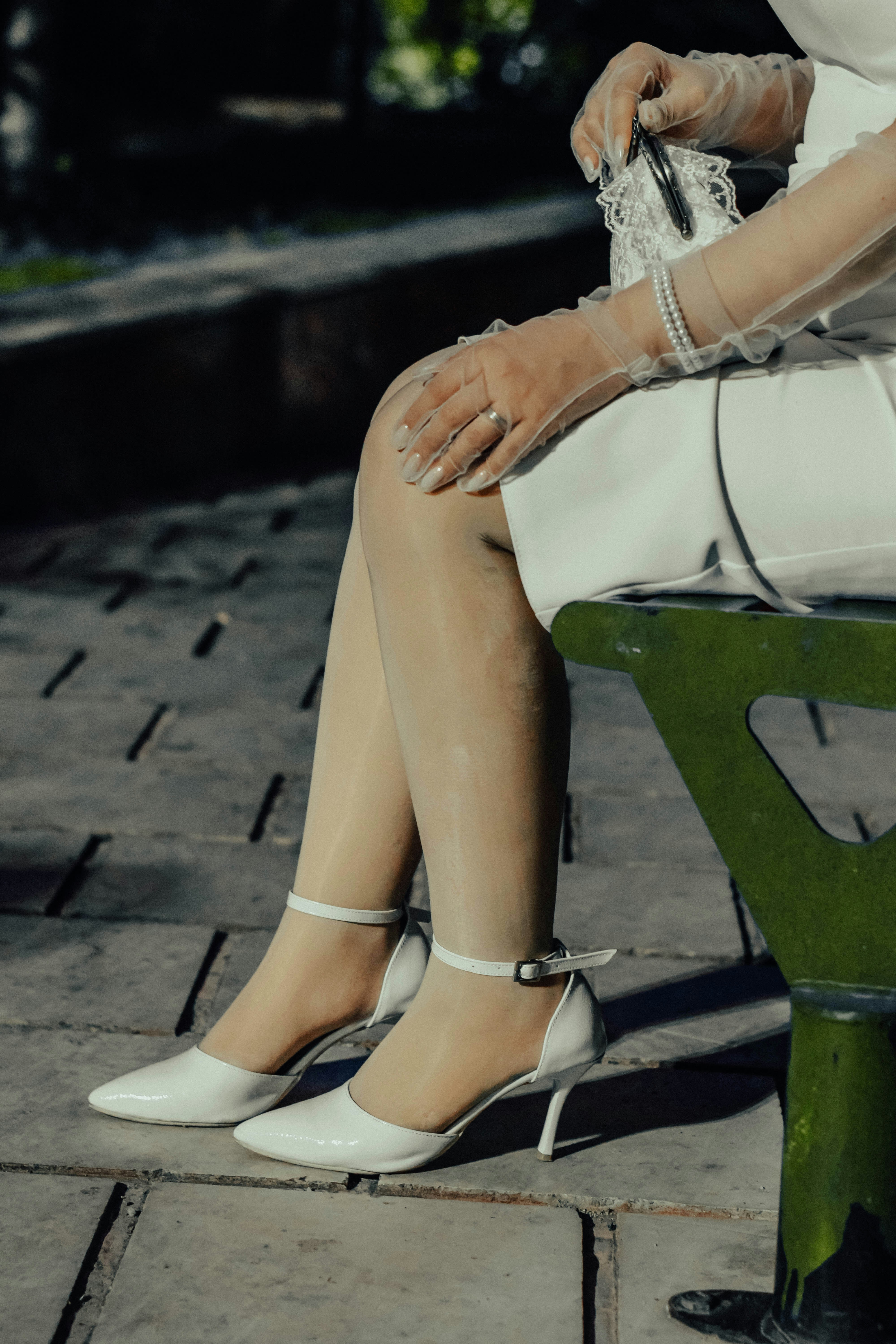 Silk Glimpse: Bride's Gloved Hands and White Shoes