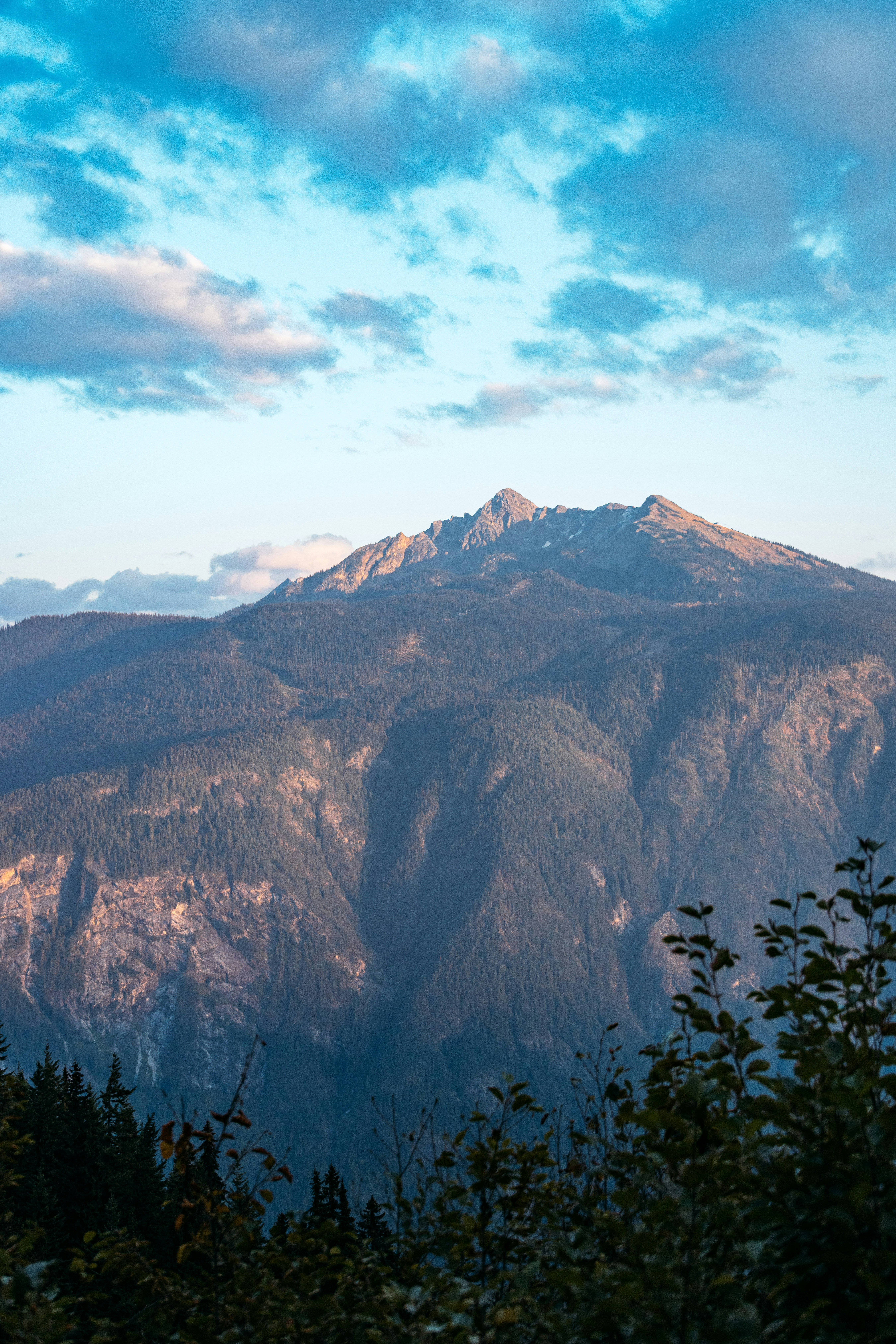 Crowned Summit: Alpine Ridge Under a Bluish Skies