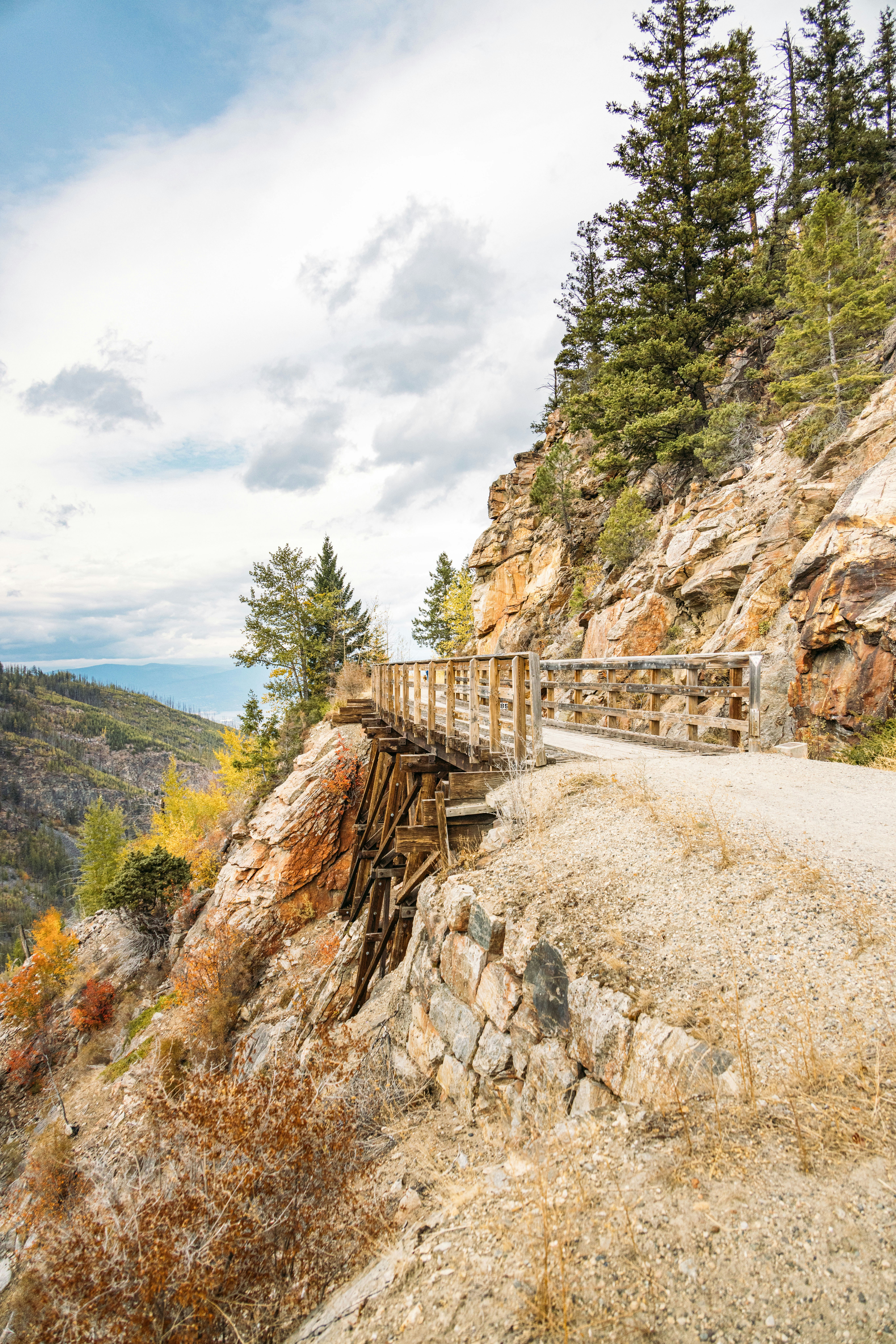 Cliffside Pathway: A Weathered Bridge Delicately Spanning the Mountain Toa