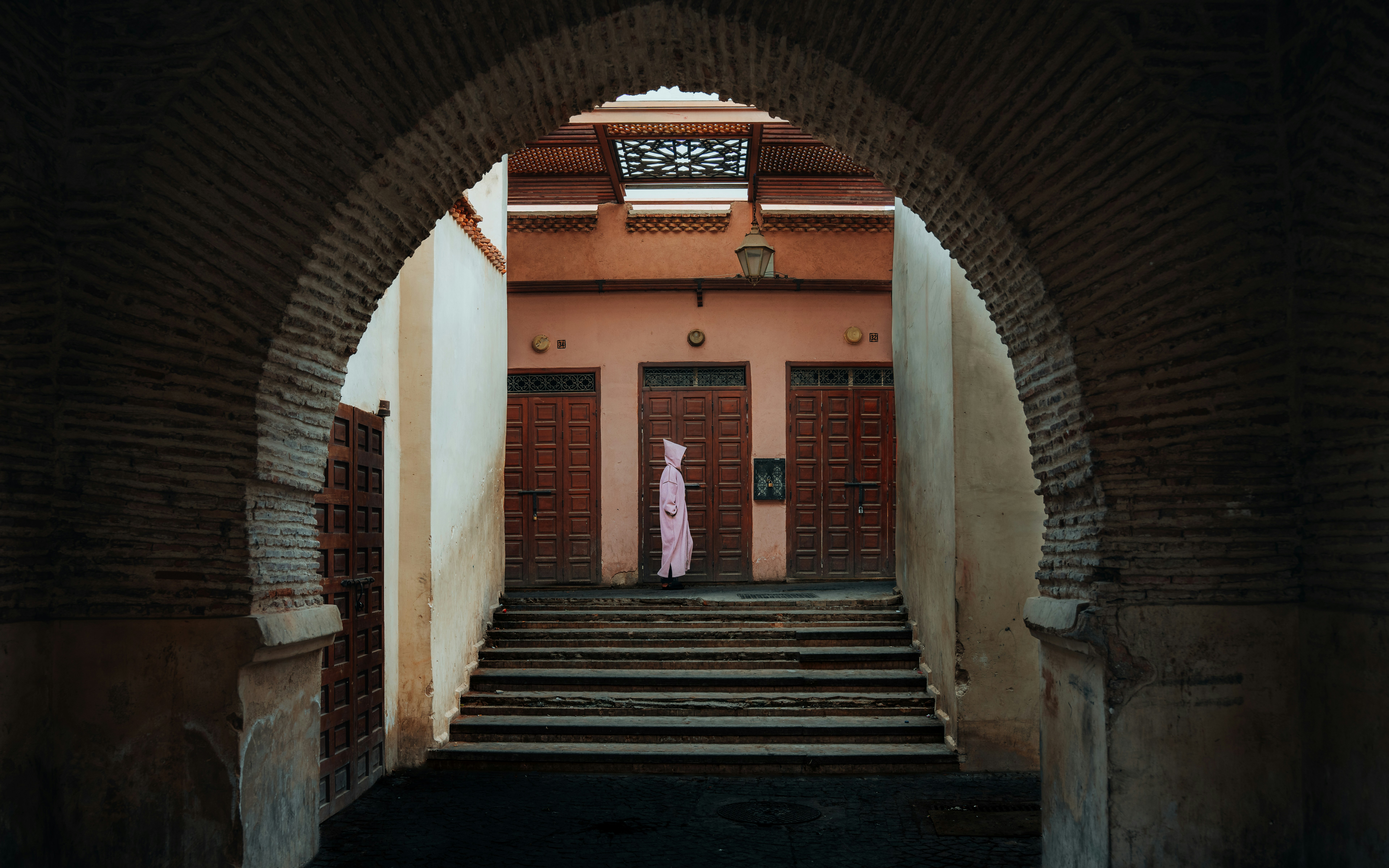 A Quiet Threshold: A Lantern-Haloed Passage Through an Ancient Archway