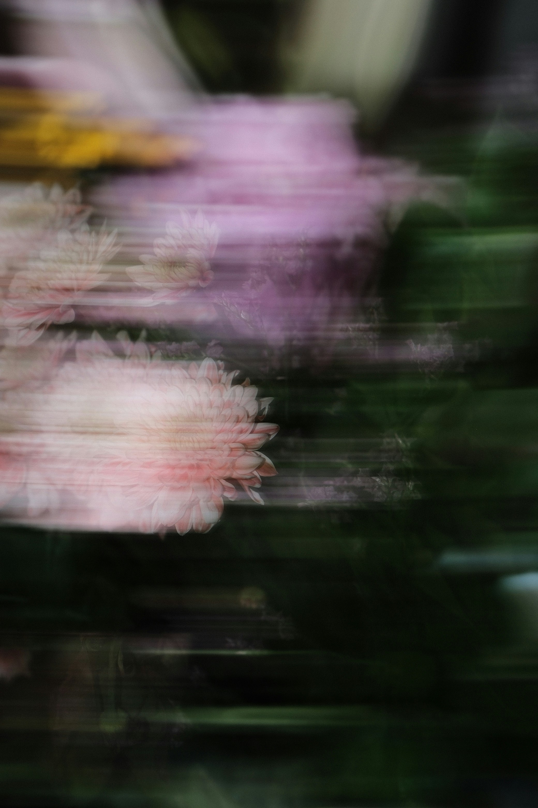 Abstract blur of pink, yellow, and green colors.