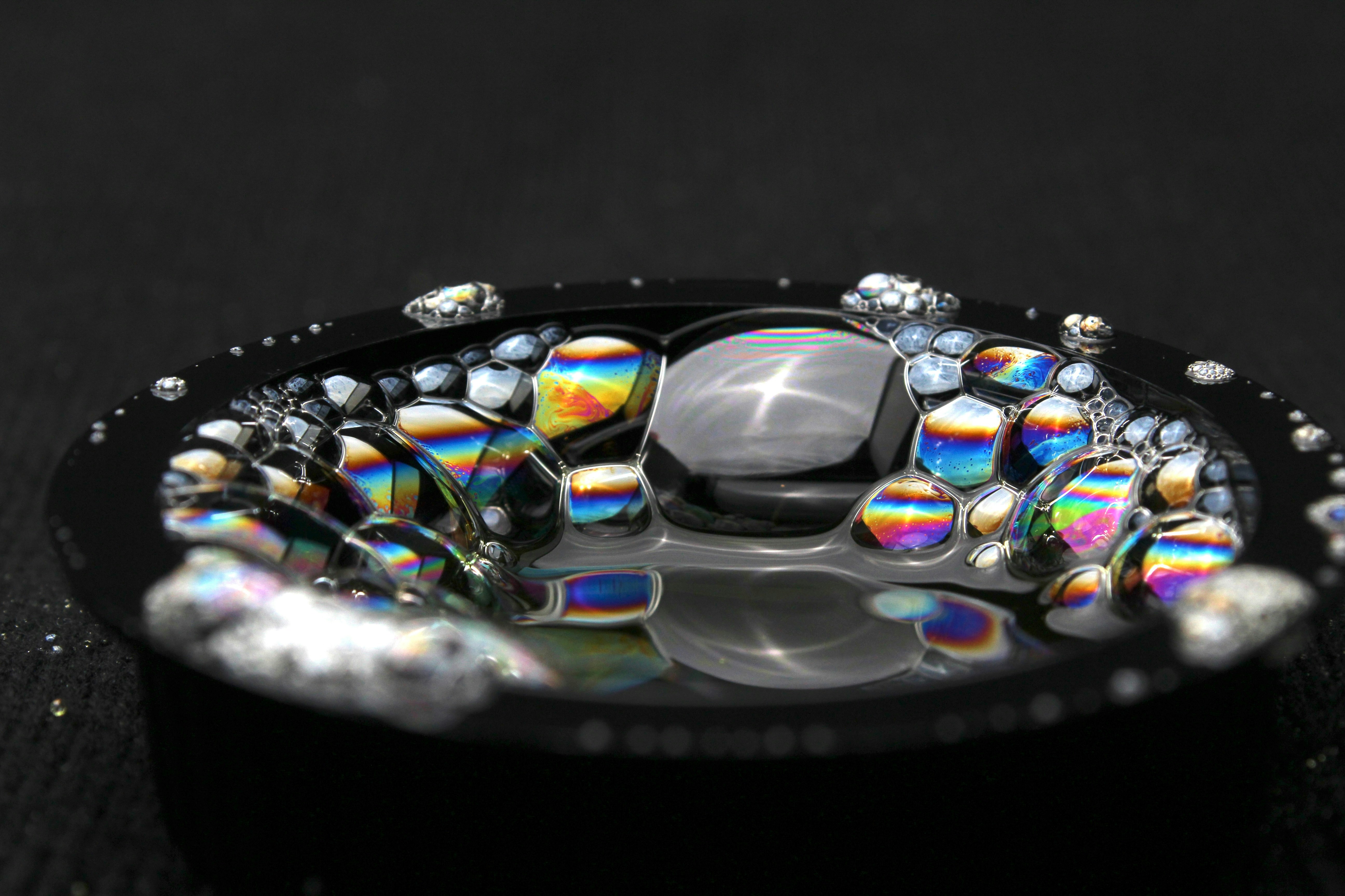 Chromatic Droplets on a Micro-Cap Surface